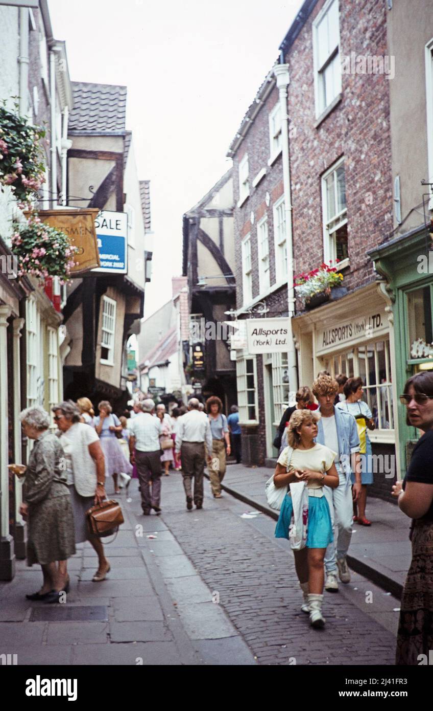 People walking along narrow medieval pedestrianised street of the ...