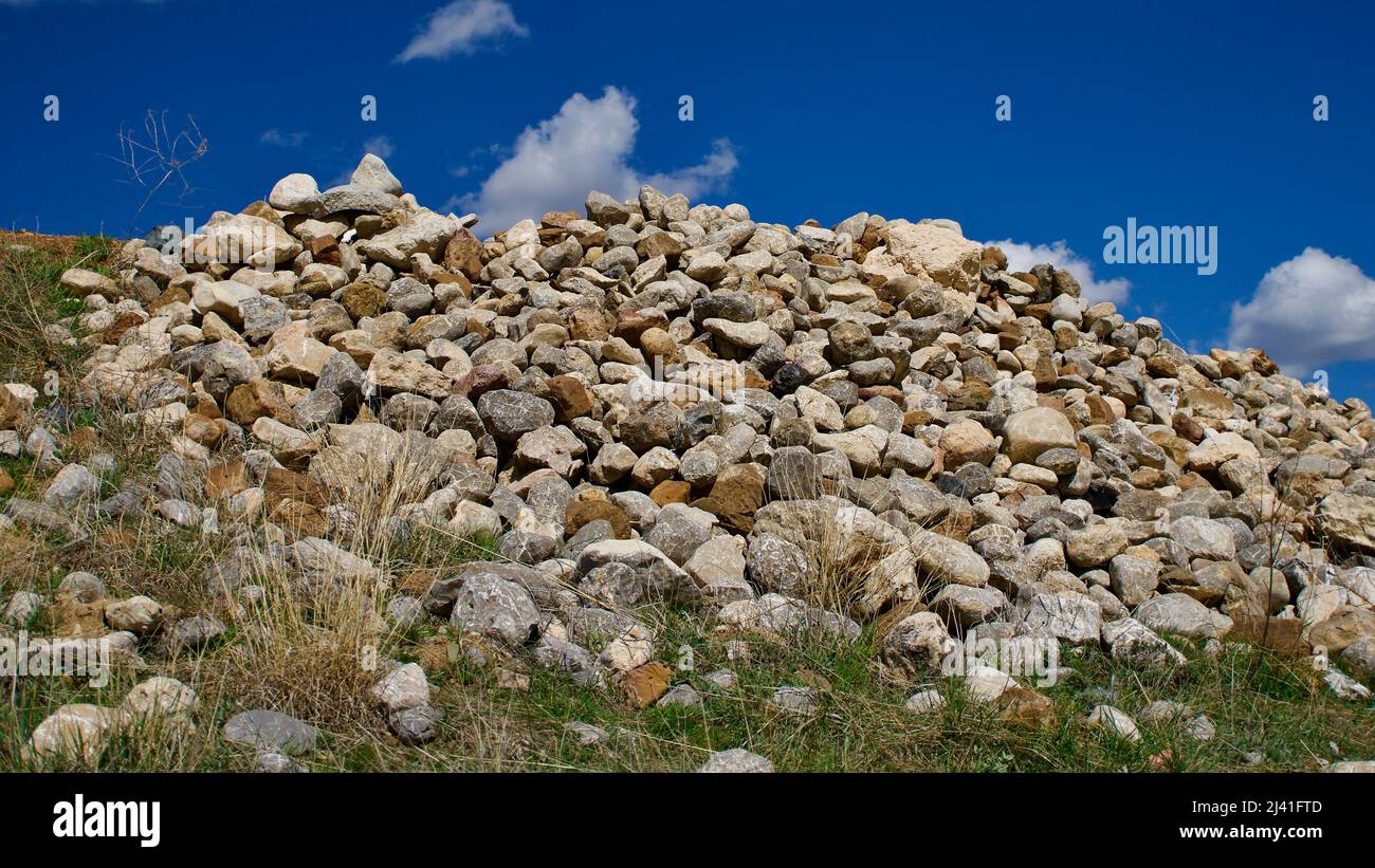 Stones of various structures deposited on the edge of the field. Heap ...