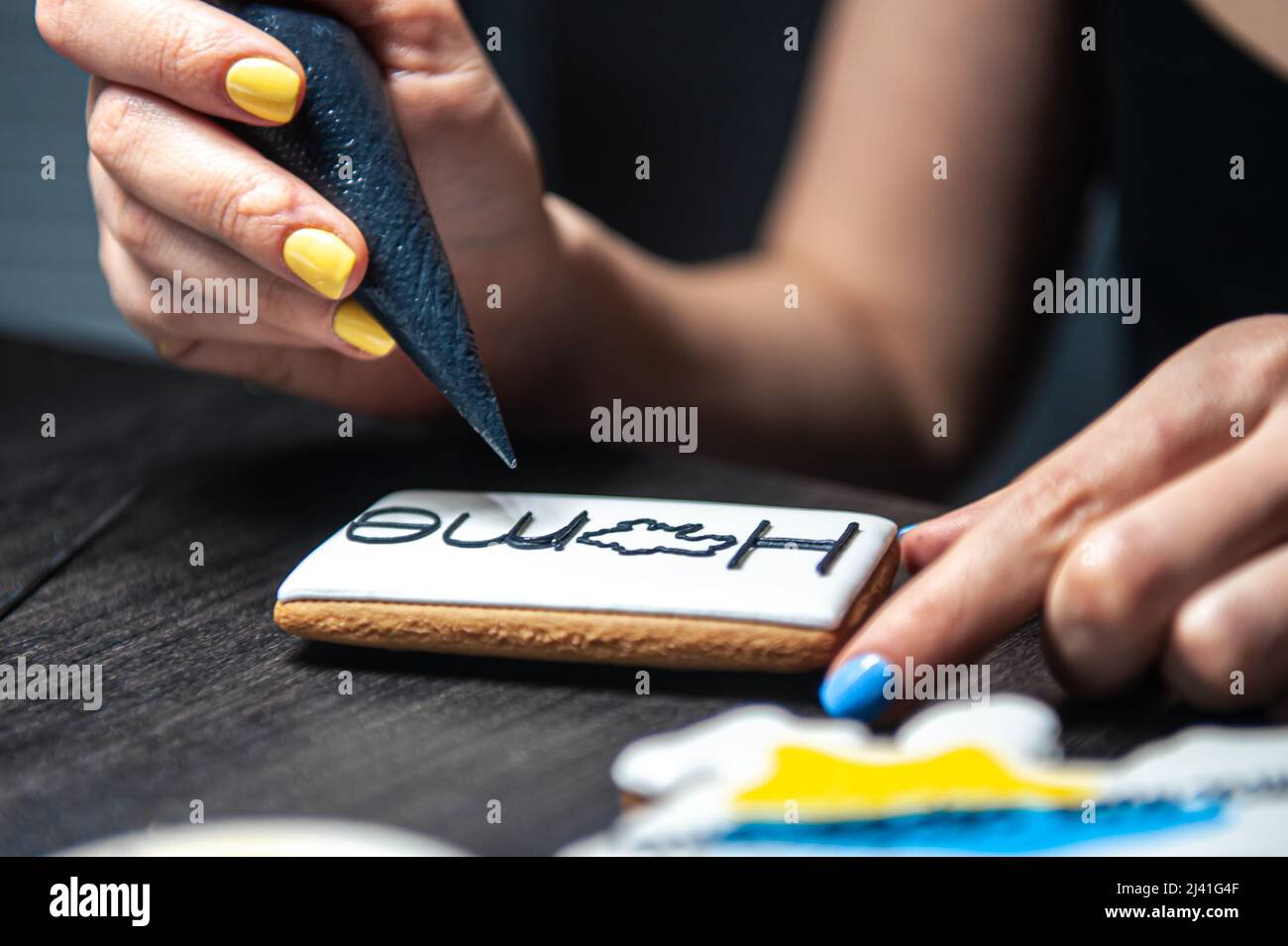 A woman makes patriotic gingerbread in support of Ukraine Stock Photo ...