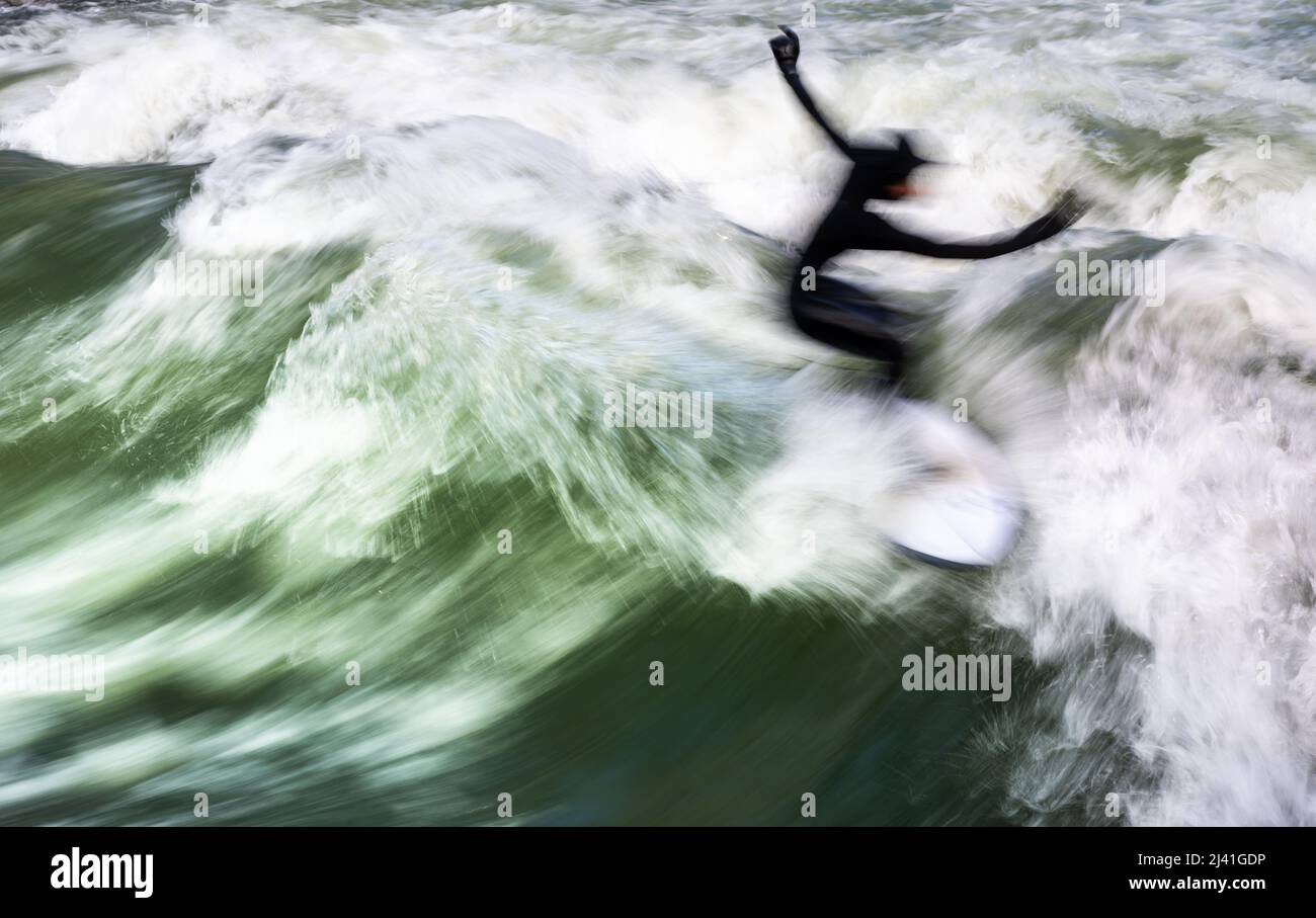 Munich, Germany. 11th Apr, 2022. A man rides the Eisbach wave in the ...