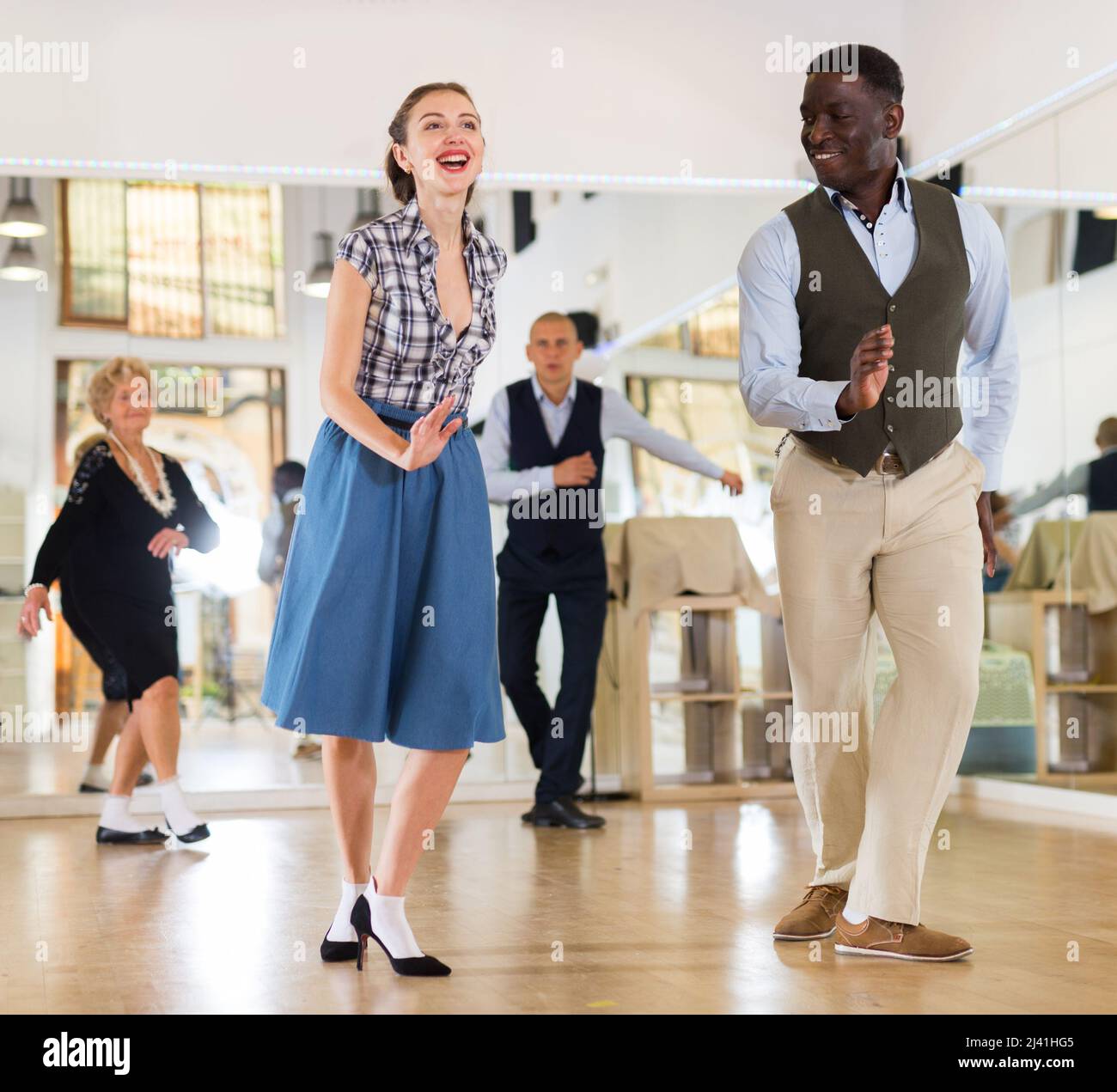 Woman with african man practising charleston dancing Stock Photo - Alamy