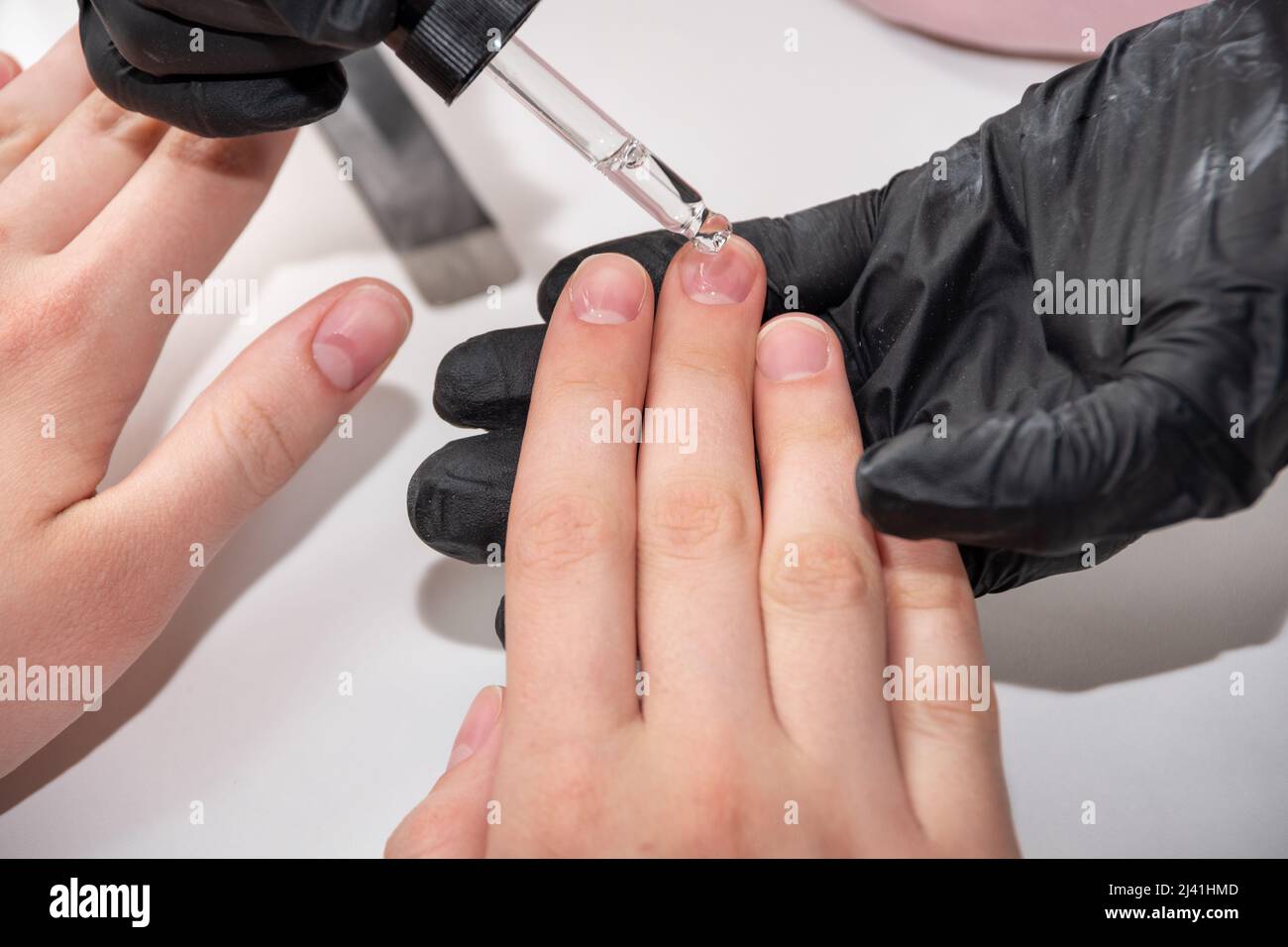 Applying oil on the nail to nourish and treat the cuticle after ...