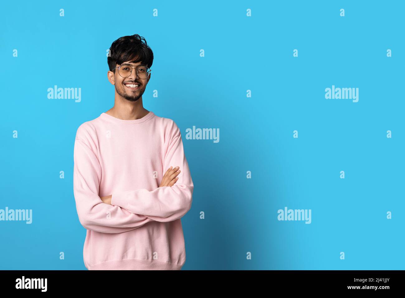 Happy hindu guy standing by copy space for advertisement Stock Photo ...