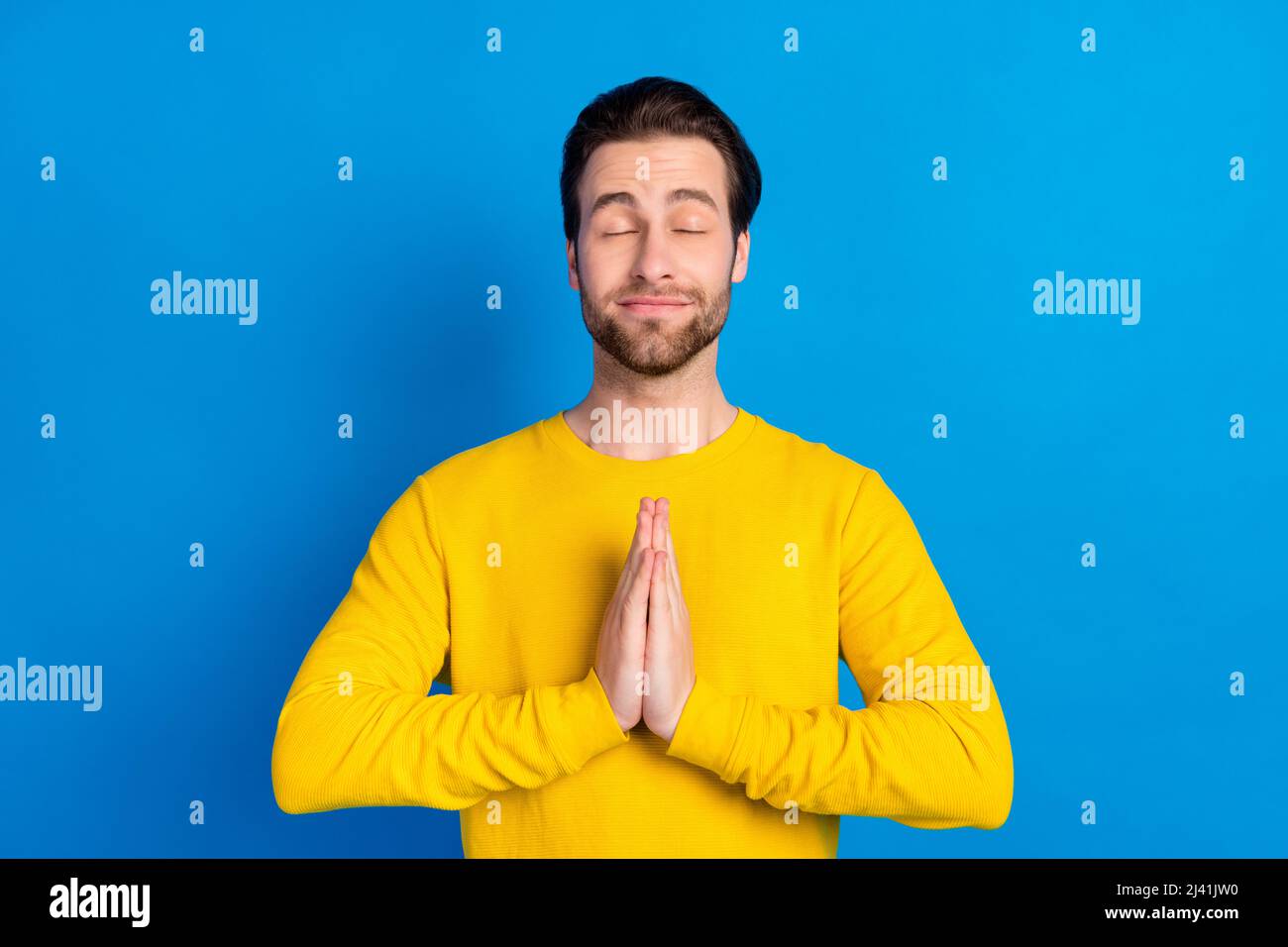 Portrait of attractive dreamy calm brunet guy meditating isolated over ...