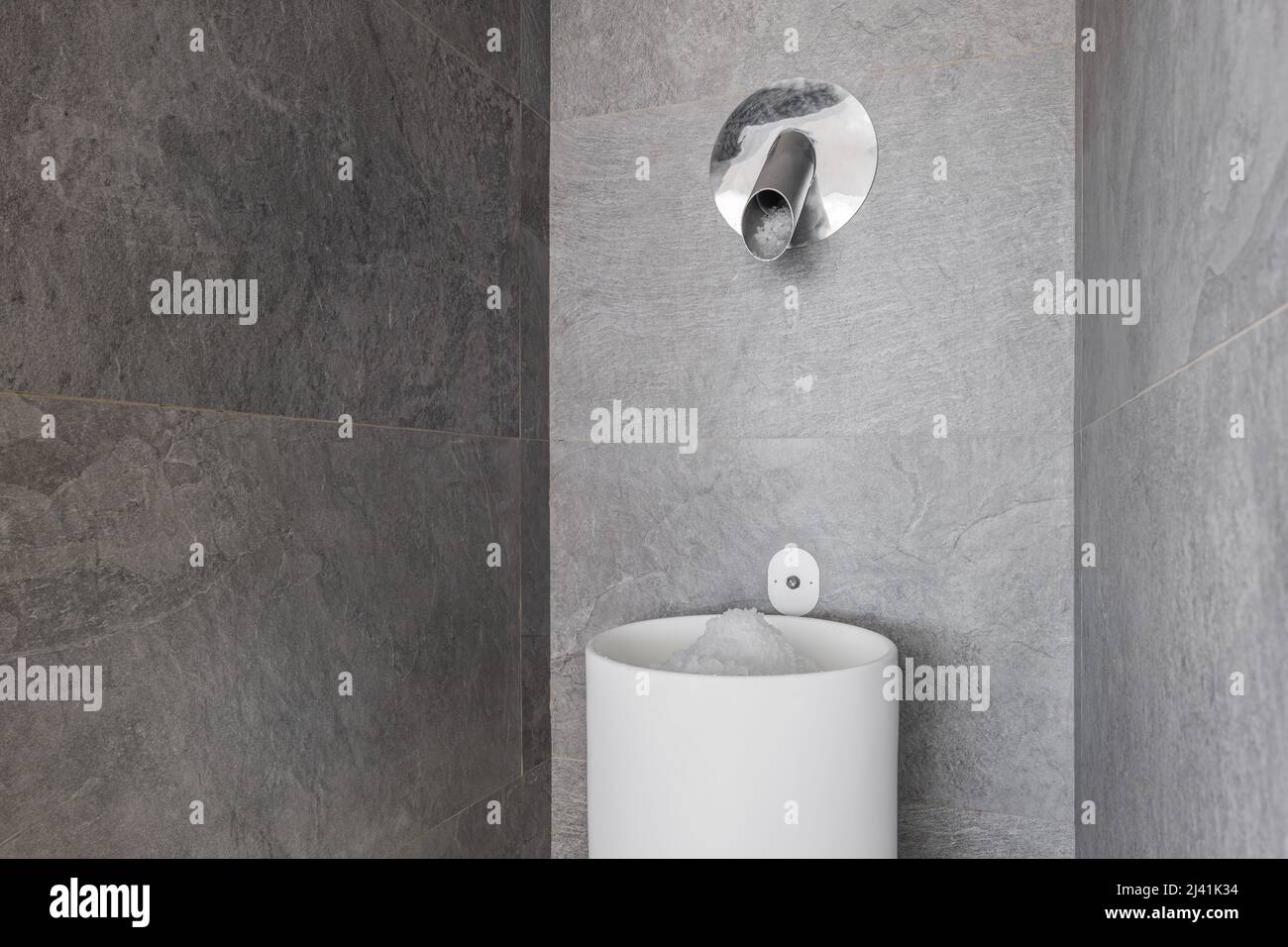 Ice maker in a modern sauna with gray marble walls in wellness spa ...