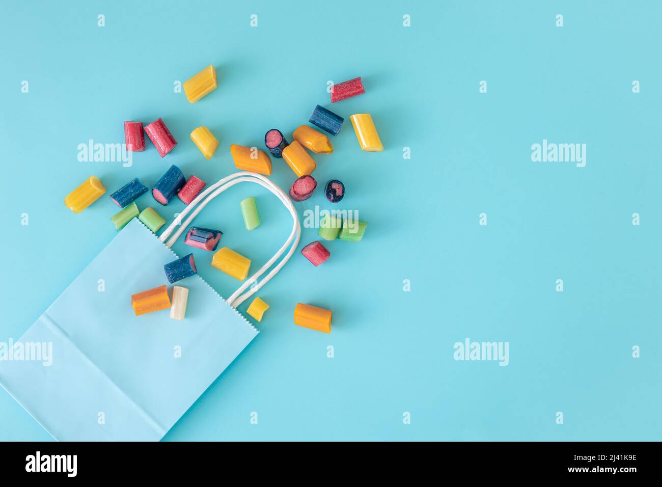 Flat lay, paper bag and chewing bags on a blue background Stock Photo ...