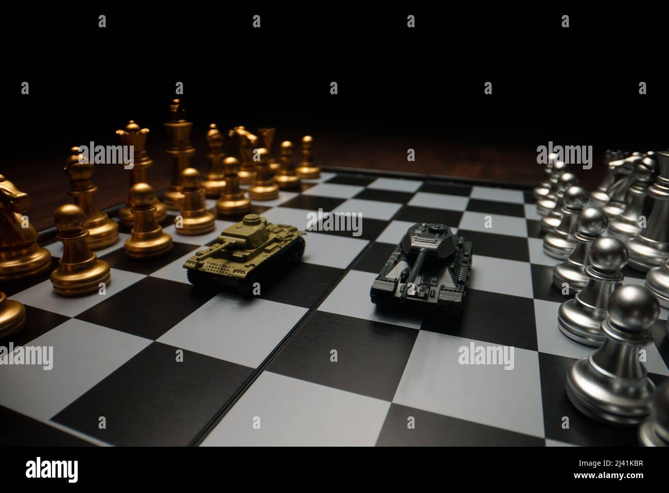 Toy tanks with chess on chessboard. Concept of military strategy Stock ...