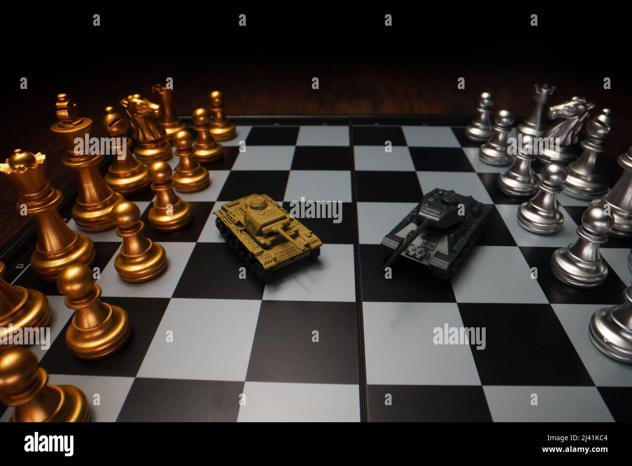 Toy tanks with chess on chessboard. Concept of military strategy Stock ...