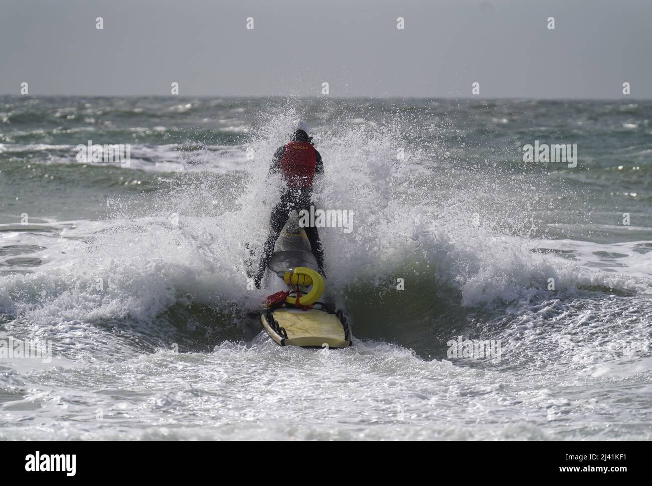 A RNLI lifeguard on a jet ski hits the waves in Bournemouth. Picture ...