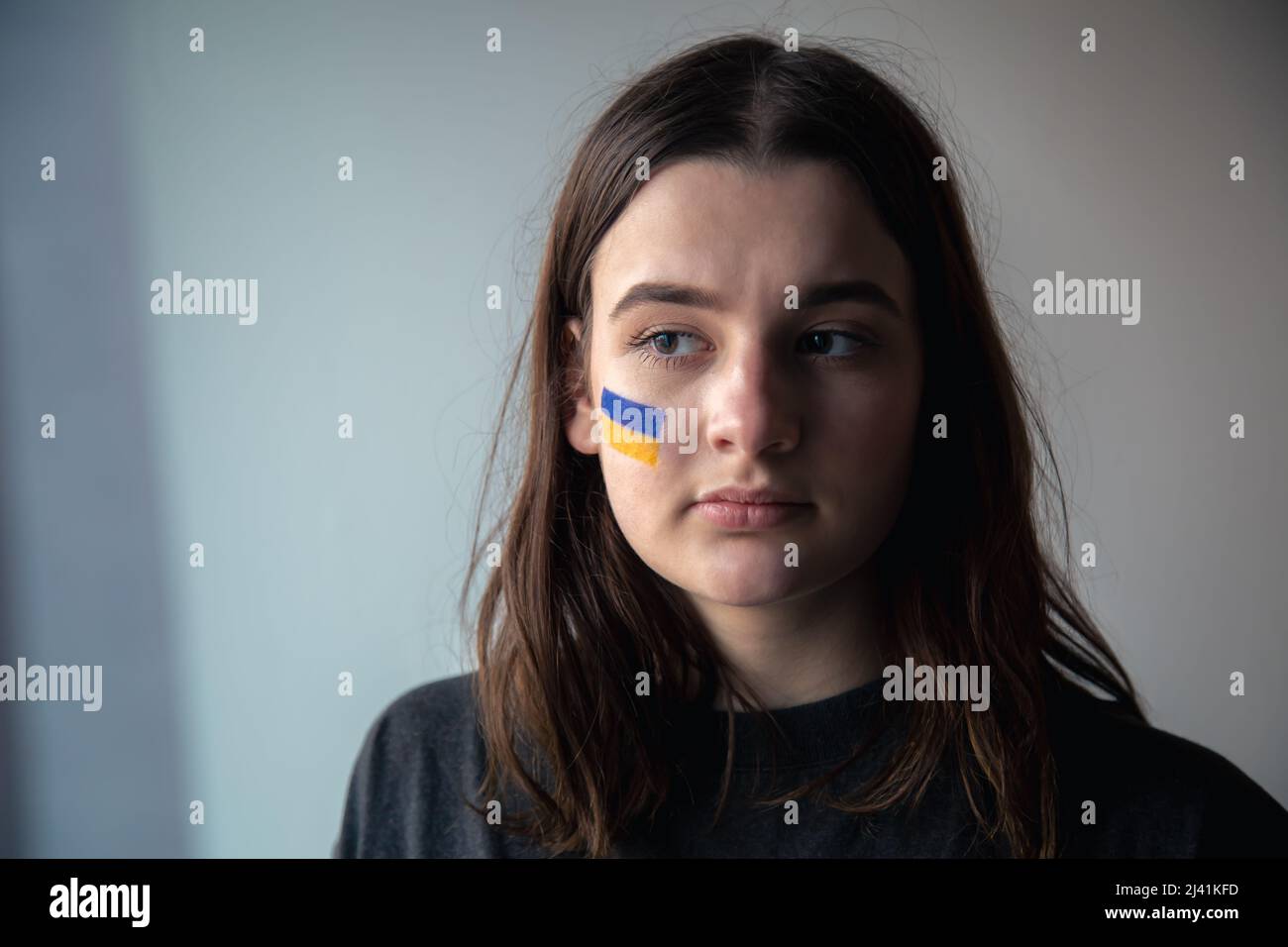 A Ukrainian girl with a painted flag of Ukraine on her face Stock Photo ...