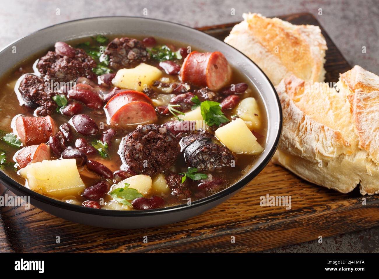 Slow Cooked Portuguese Stone Soup or Sopa da Pedra closeup in the plate ...