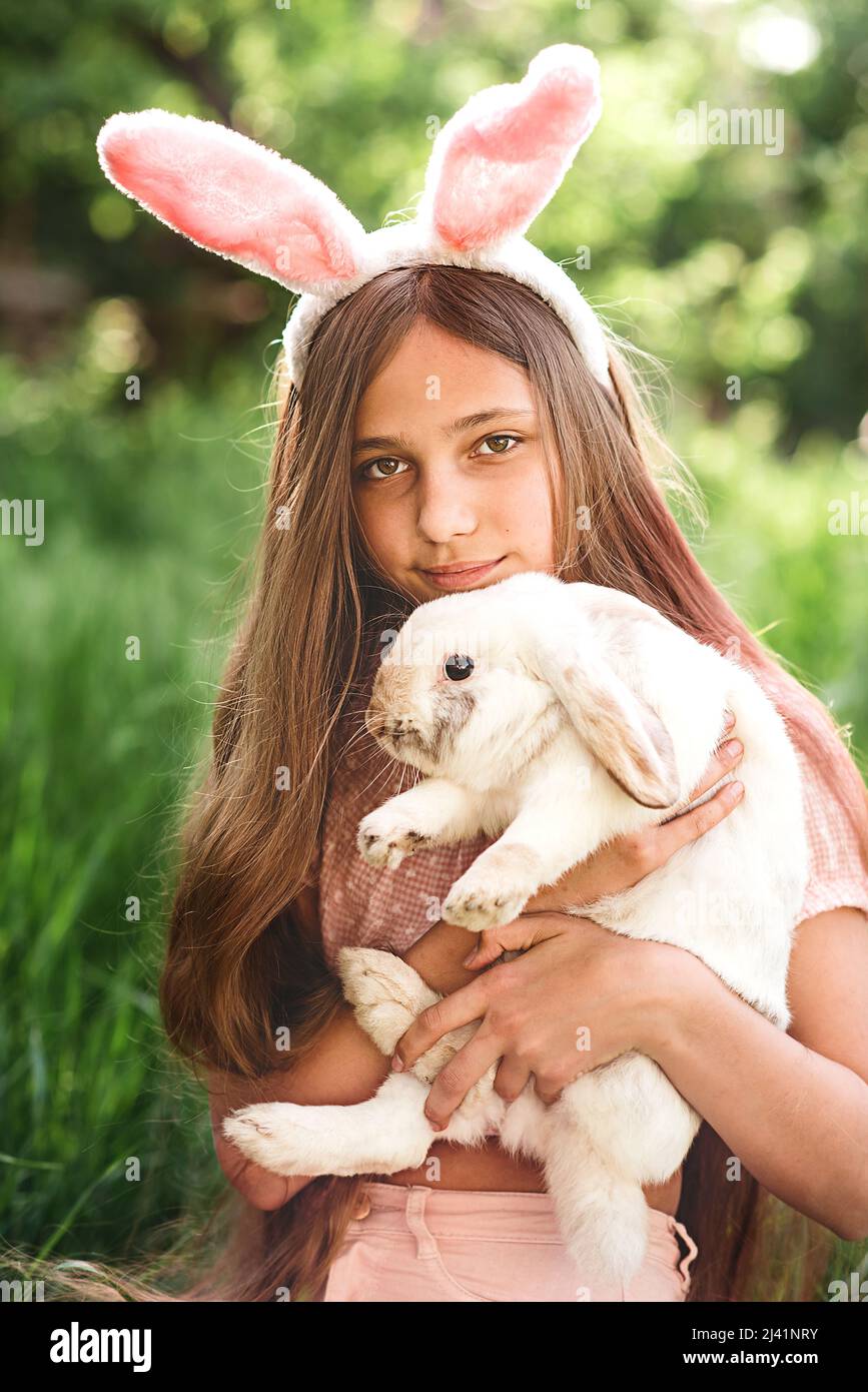 Easter egg hunt. Girl child Wearing Bunny Ears Running To Pick Up Egg ...