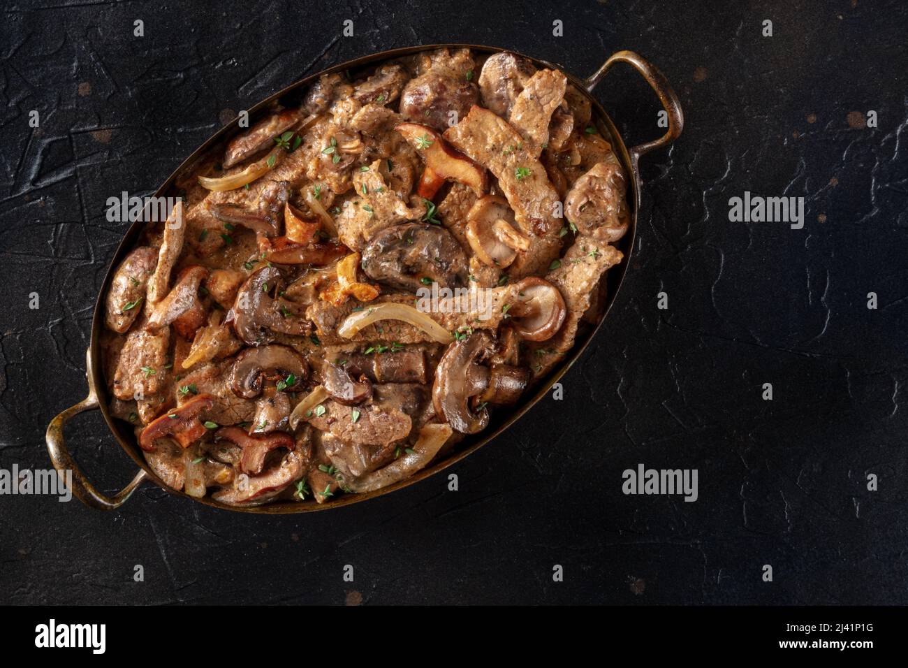 Mushroom beef stroganoff. Meat with champignons, boletus and ceps in a ...