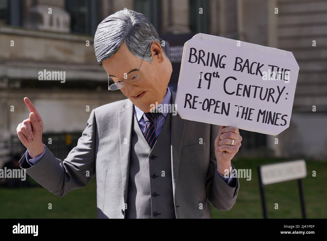 An activists from Extinction Rebellion wears a mask as they demonstrate ...