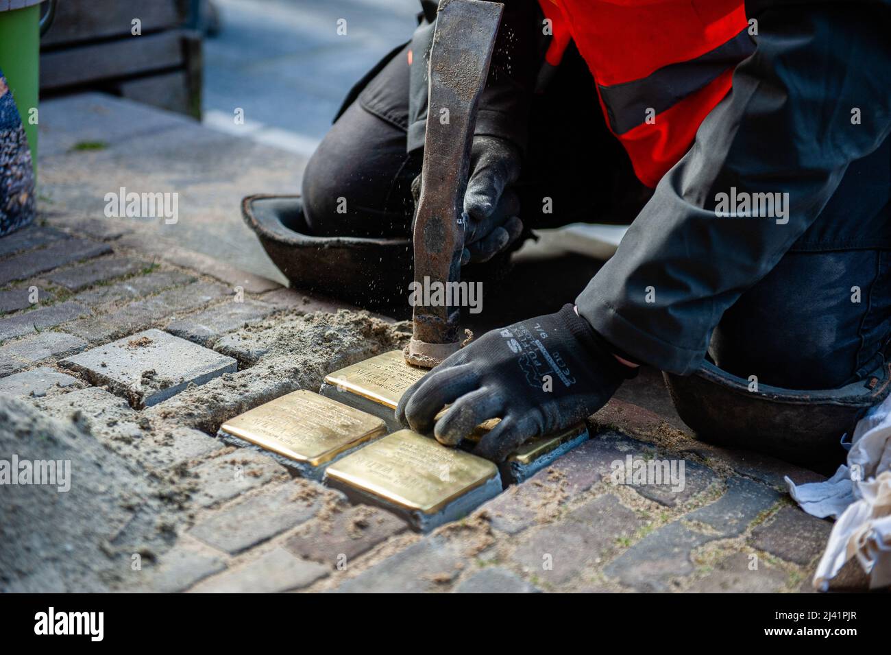 A man is seen placing stumbling stones on the floor. As the beginning ...
