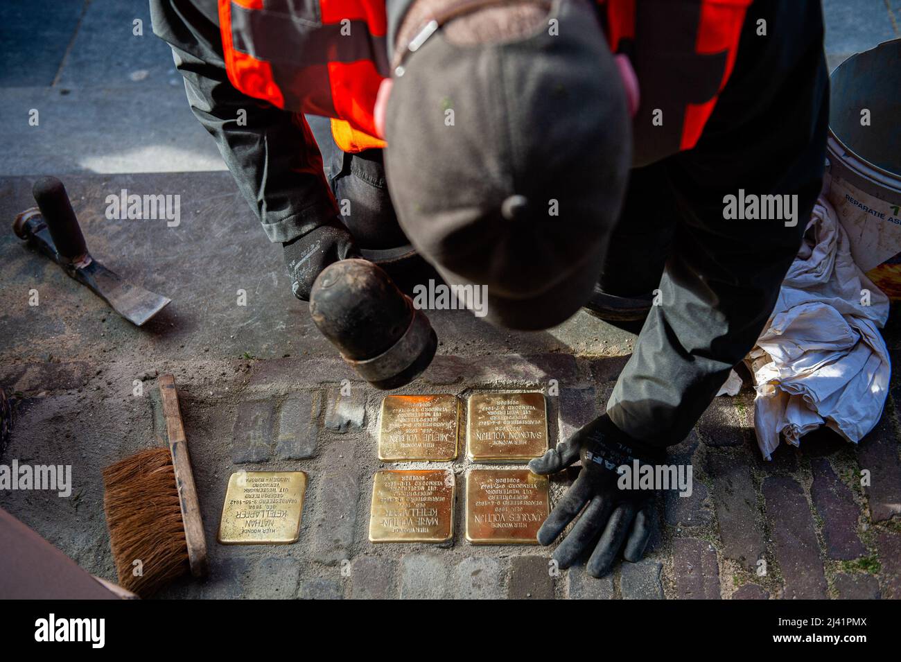 A man is seen placing stumbling stones on the floor. As the beginning ...