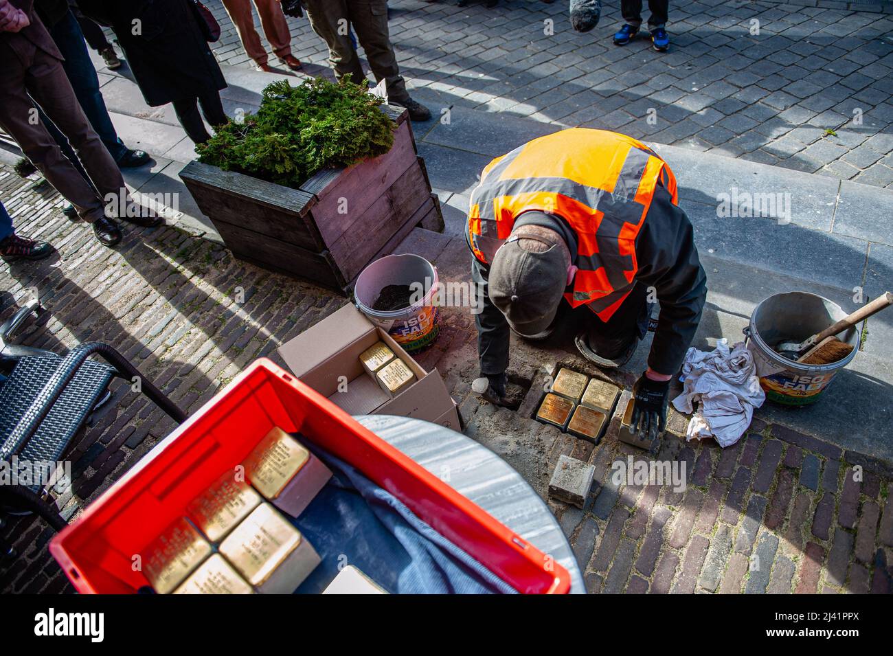 A man is seen placing stumbling stones on the floor. As the beginning ...