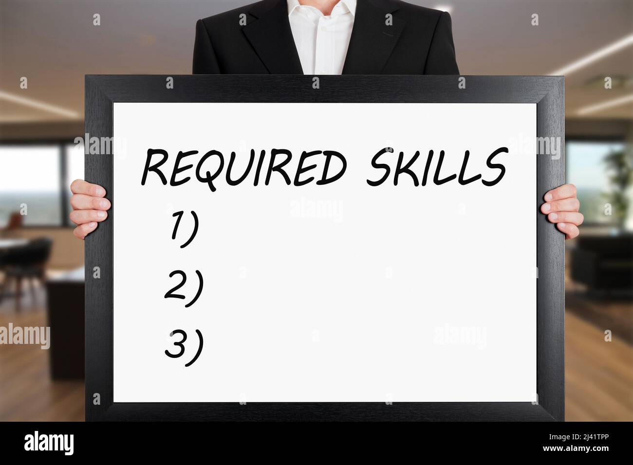 Businessman holds a big signboard with required skills message ...