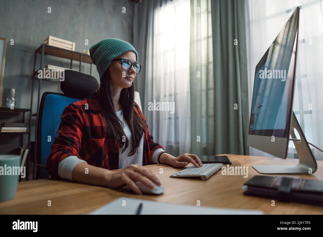 Happy female video editor works indoors in creative office studio Stock ...