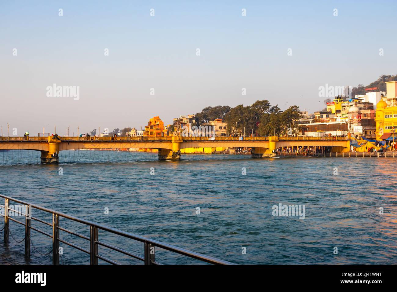bridge over flowing river near city from flat angle image is taken at ...