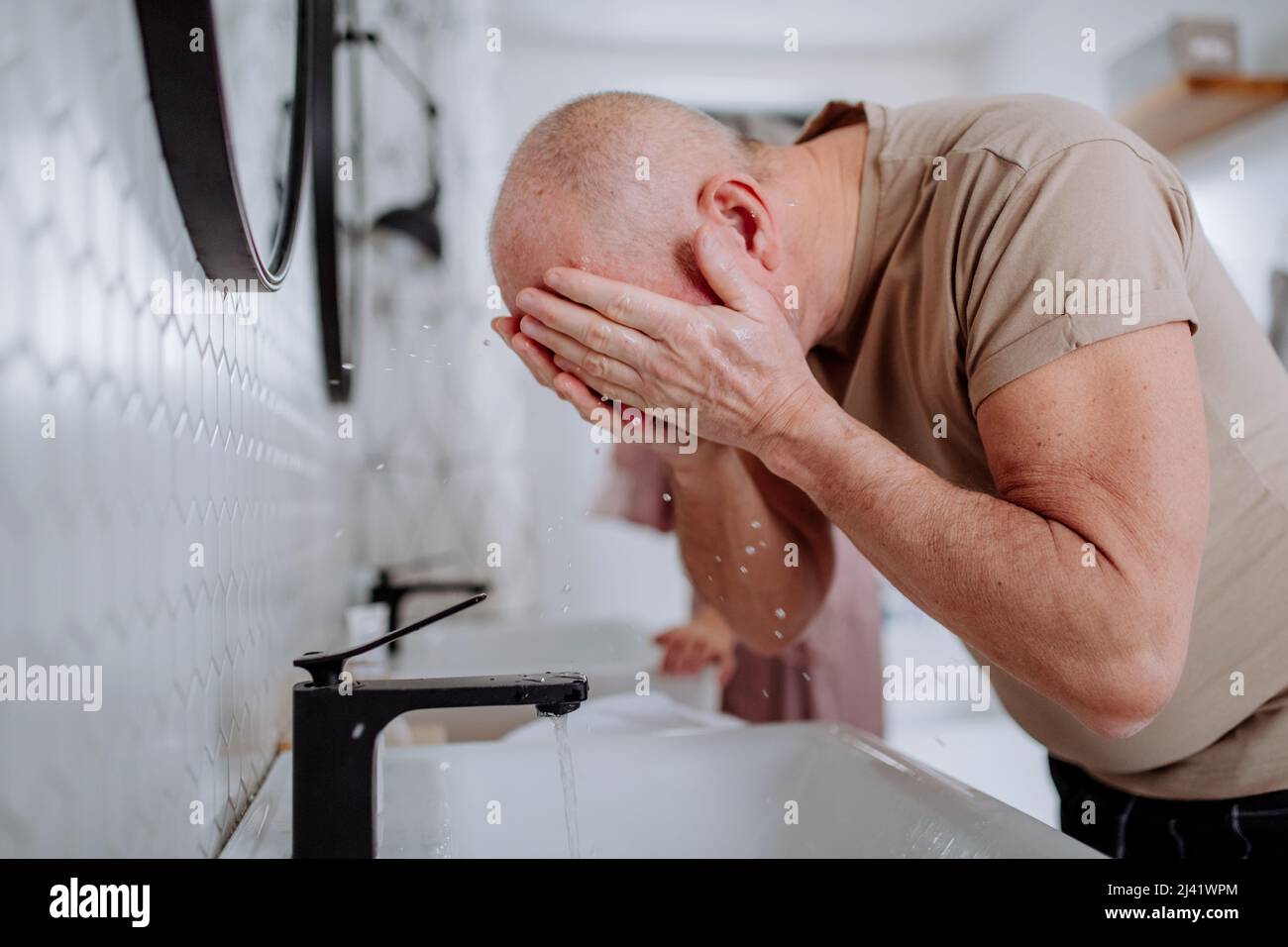 Senior couple in bathroom, washing face, morning routine concept Stock ...
