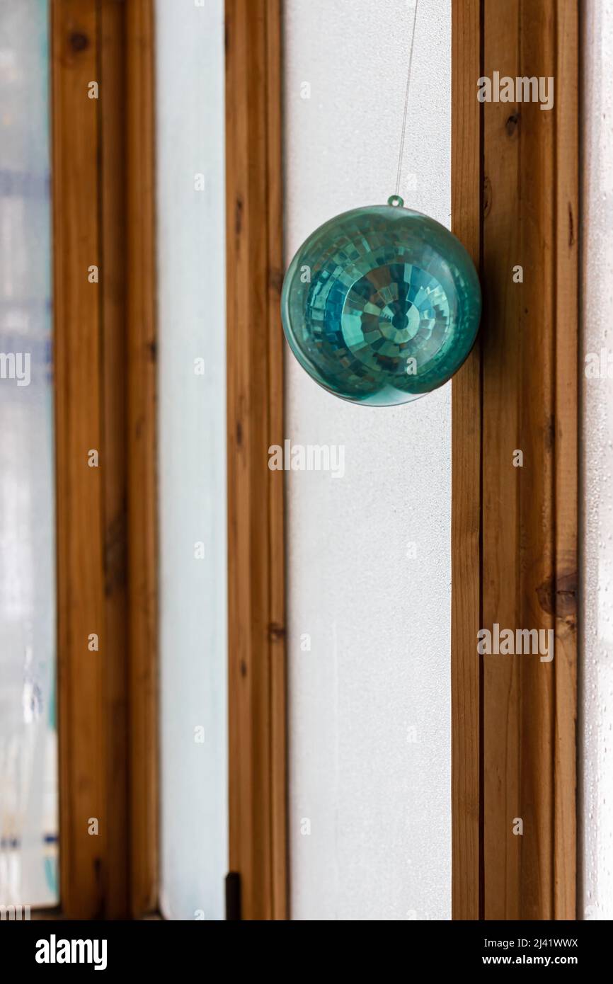 decorative shiny ball hanging on a rope on the wall. High quality photo ...