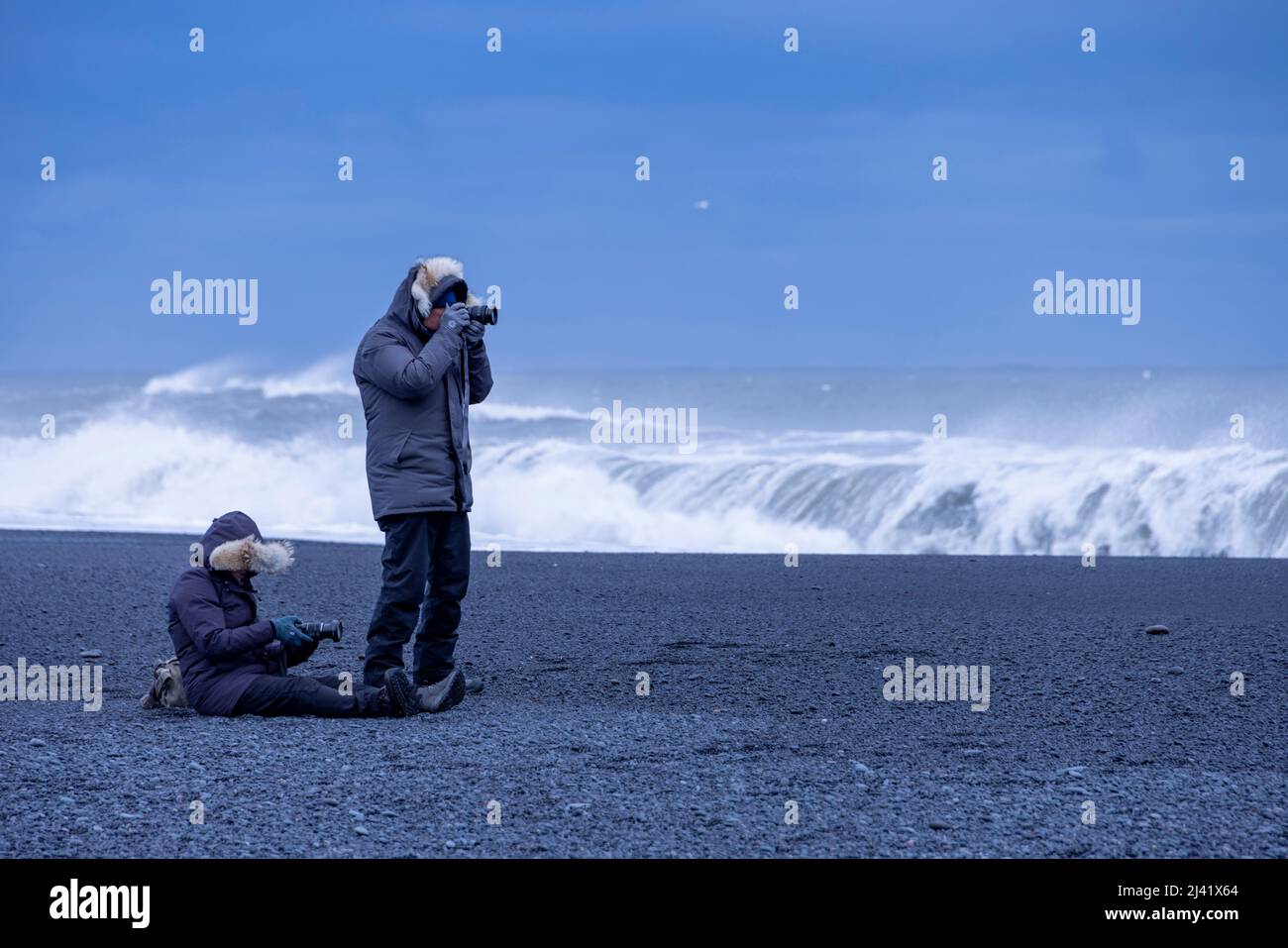 photographers on Reynisfjara Black Sand Beach, near village of Vík i ...