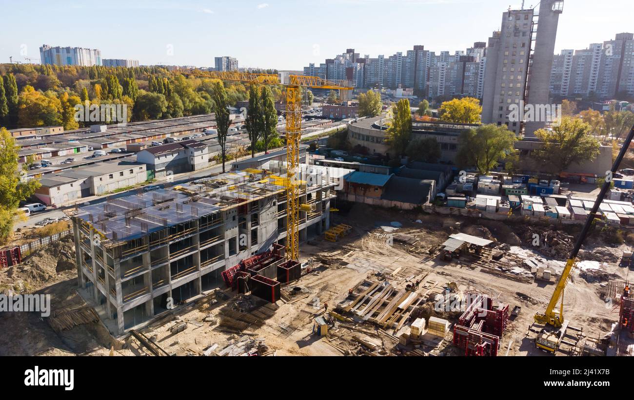 Construction site background. Hoisting cranes and new multi-storey ...