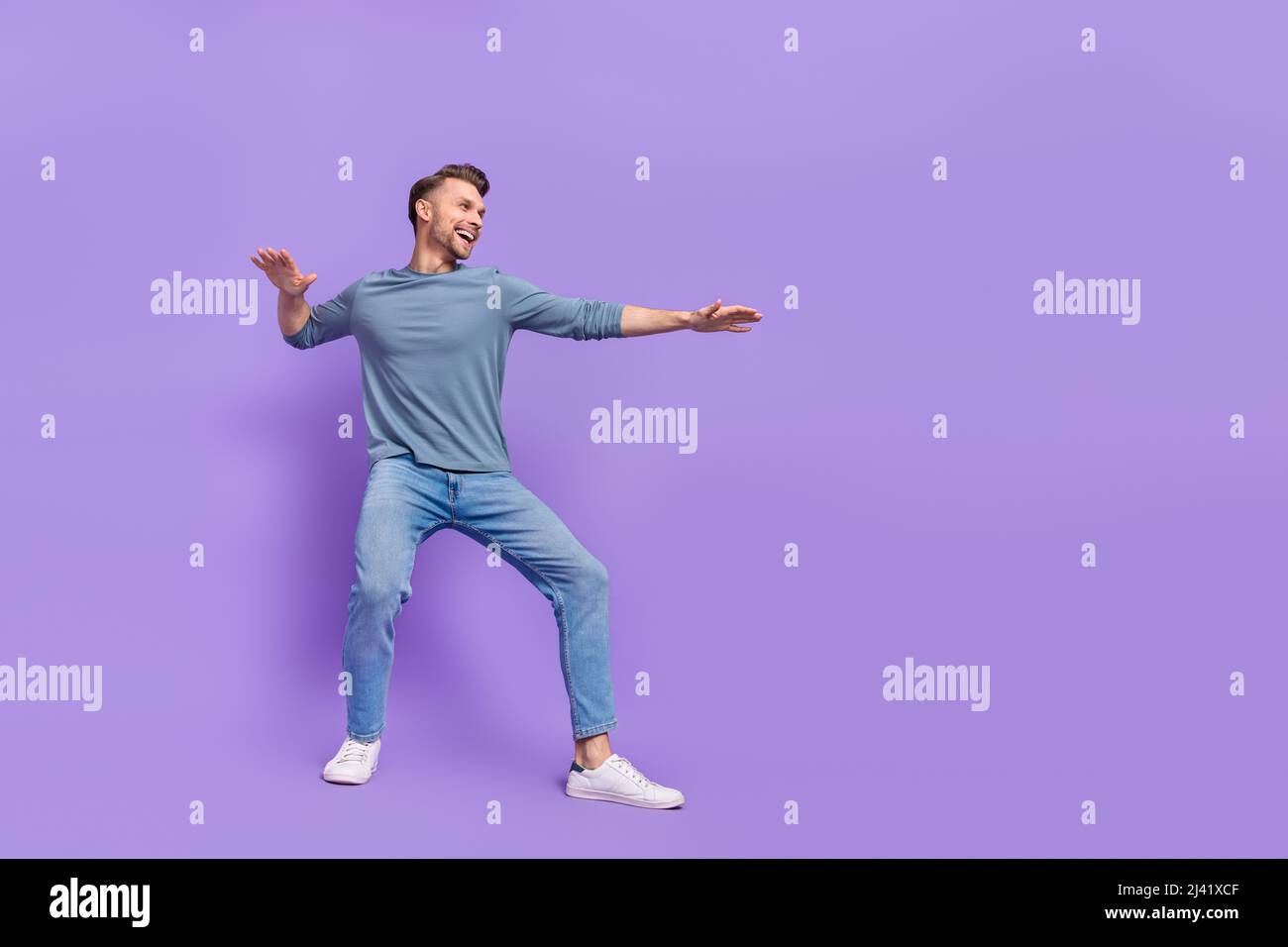 Photo of charming cool guy dressed grey shirt looking empty space ...