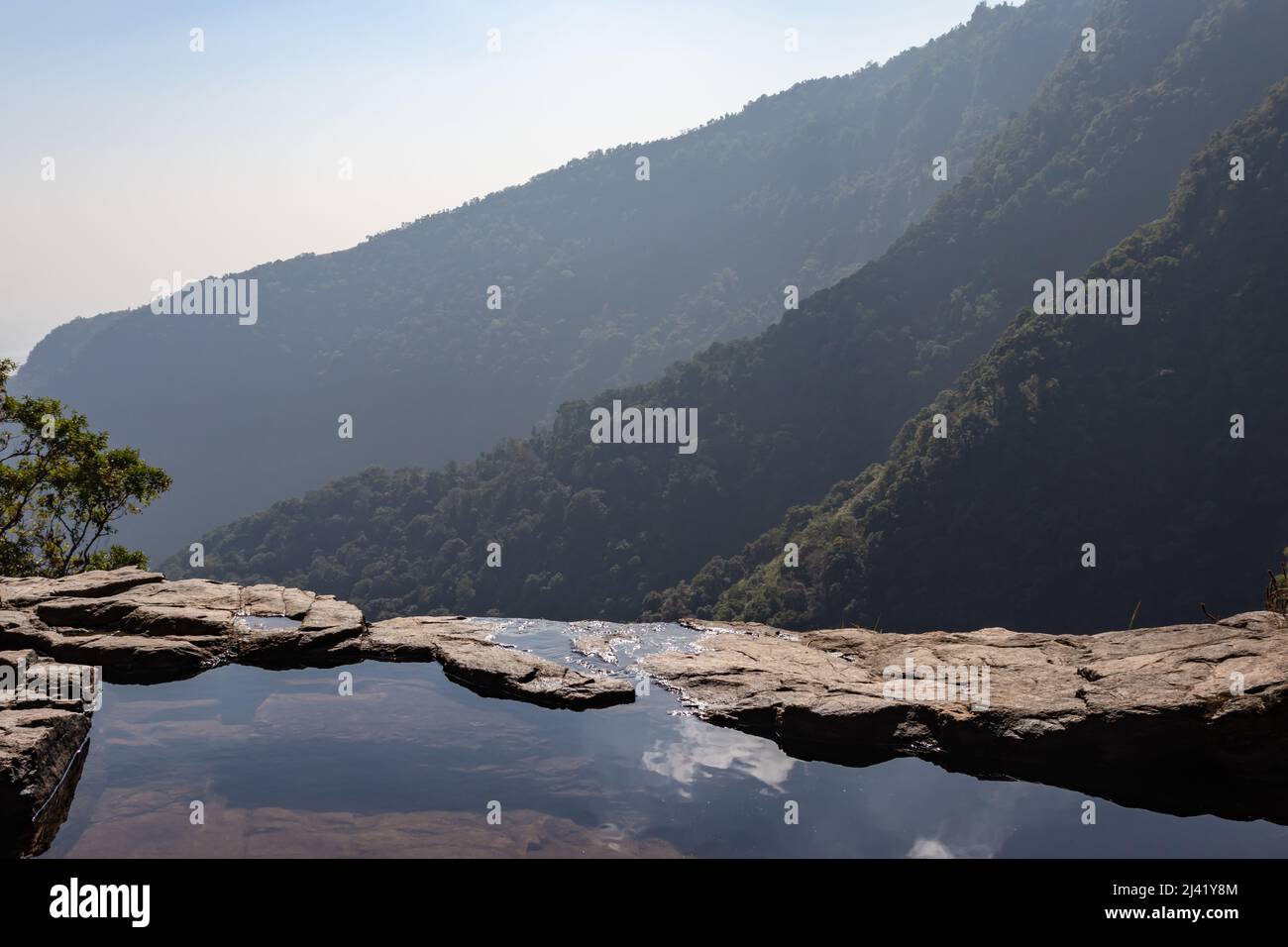 natural swimming pool with dense forests at mountain cliff from top ...