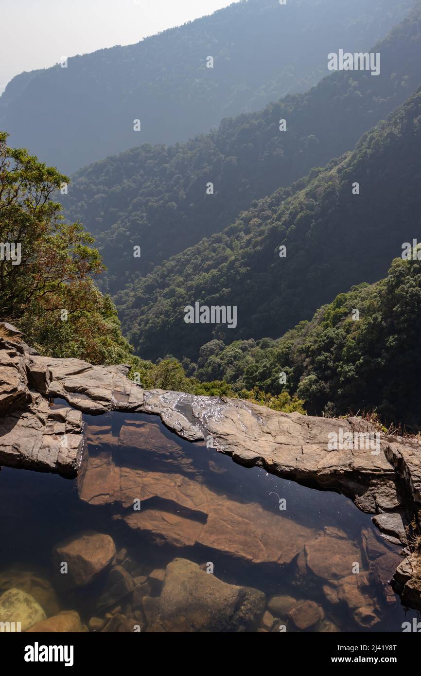 natural swimming pool with dense forests at mountain cliff from top ...