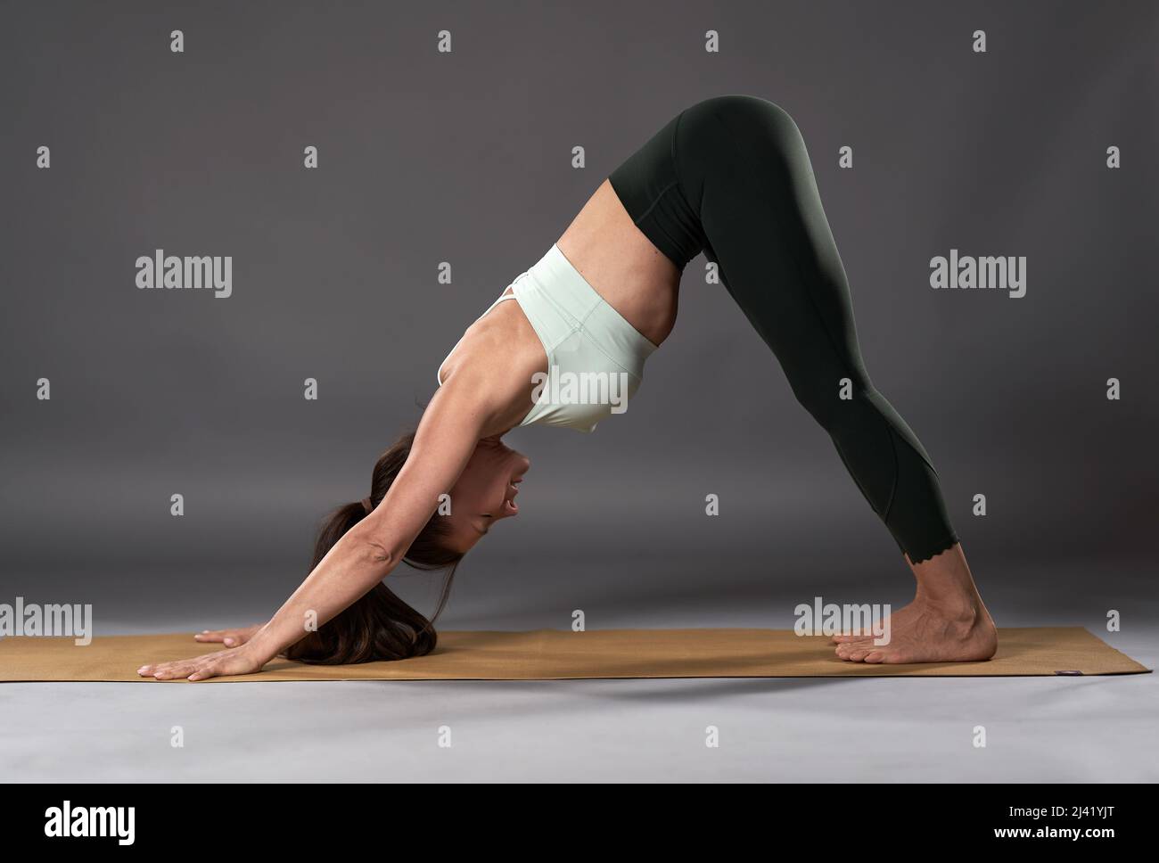 Woman yoga trainer in Adho Mukha Svanasana (downward-facing dog) pose Stock Photo - Alamy