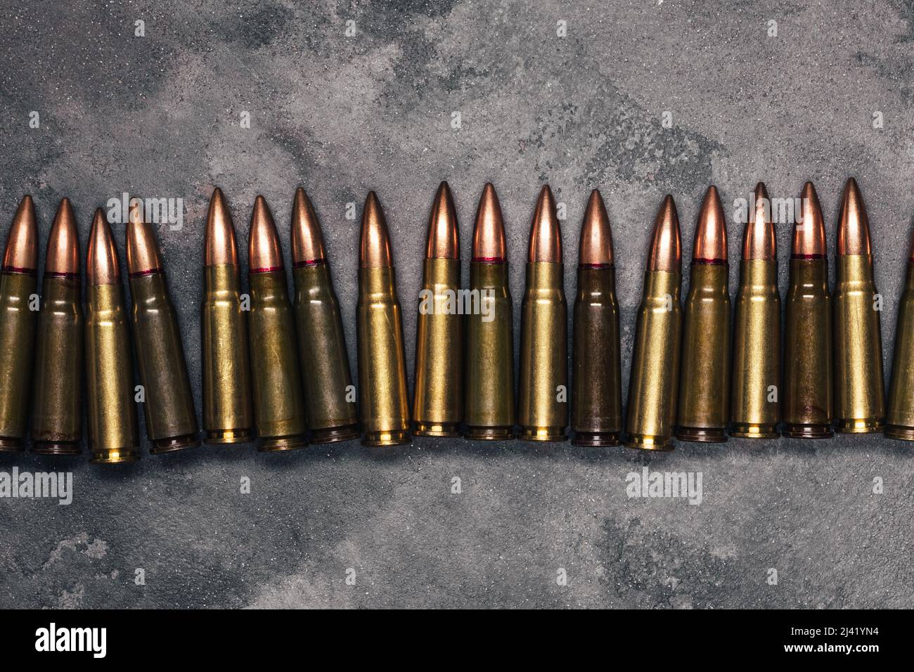 Bullets on gray background. Cartridges 7.62 caliber for Kalashnikov ...