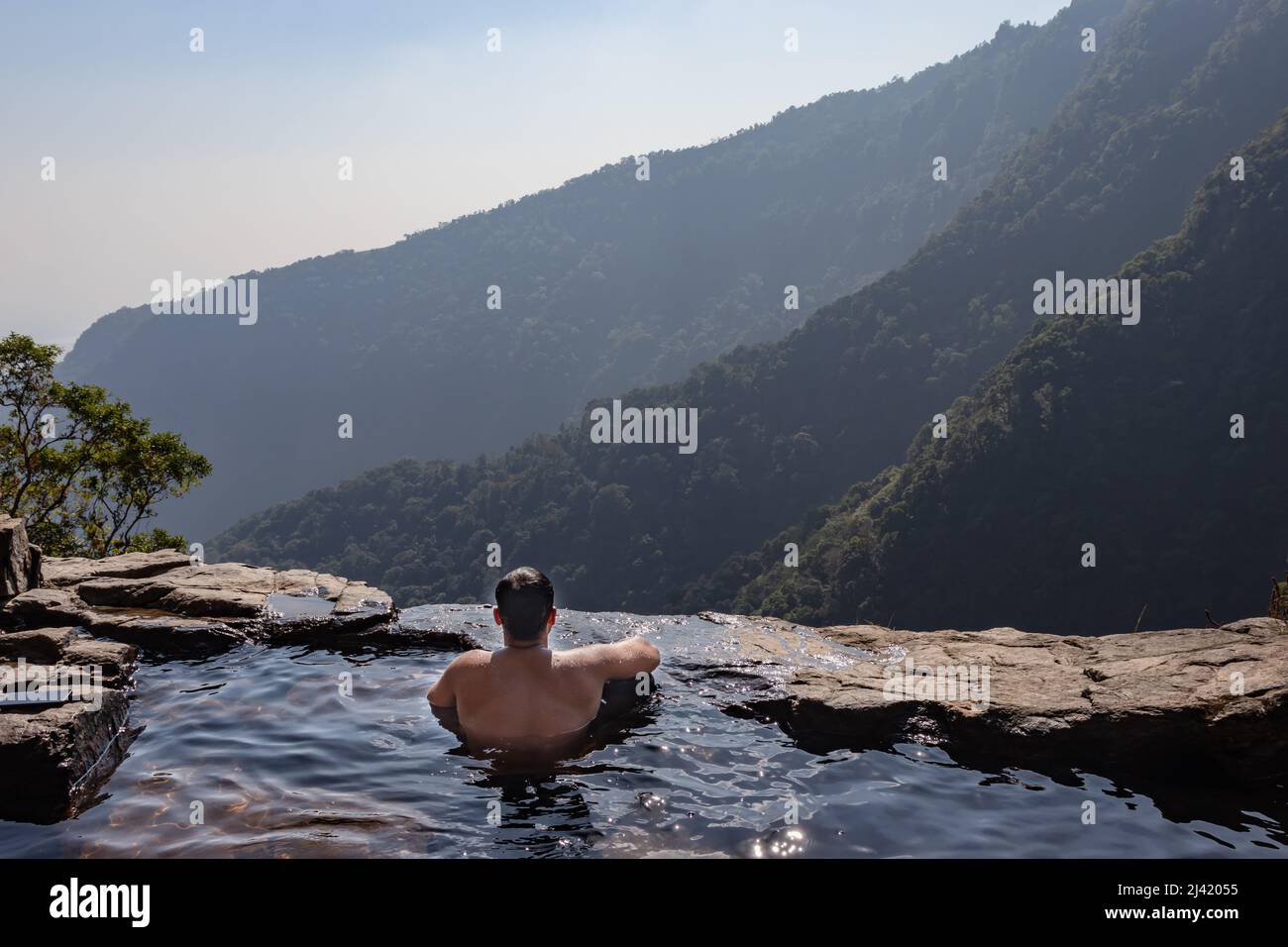 man enjoying the pristine view at natural swimming pool at mountain ...
