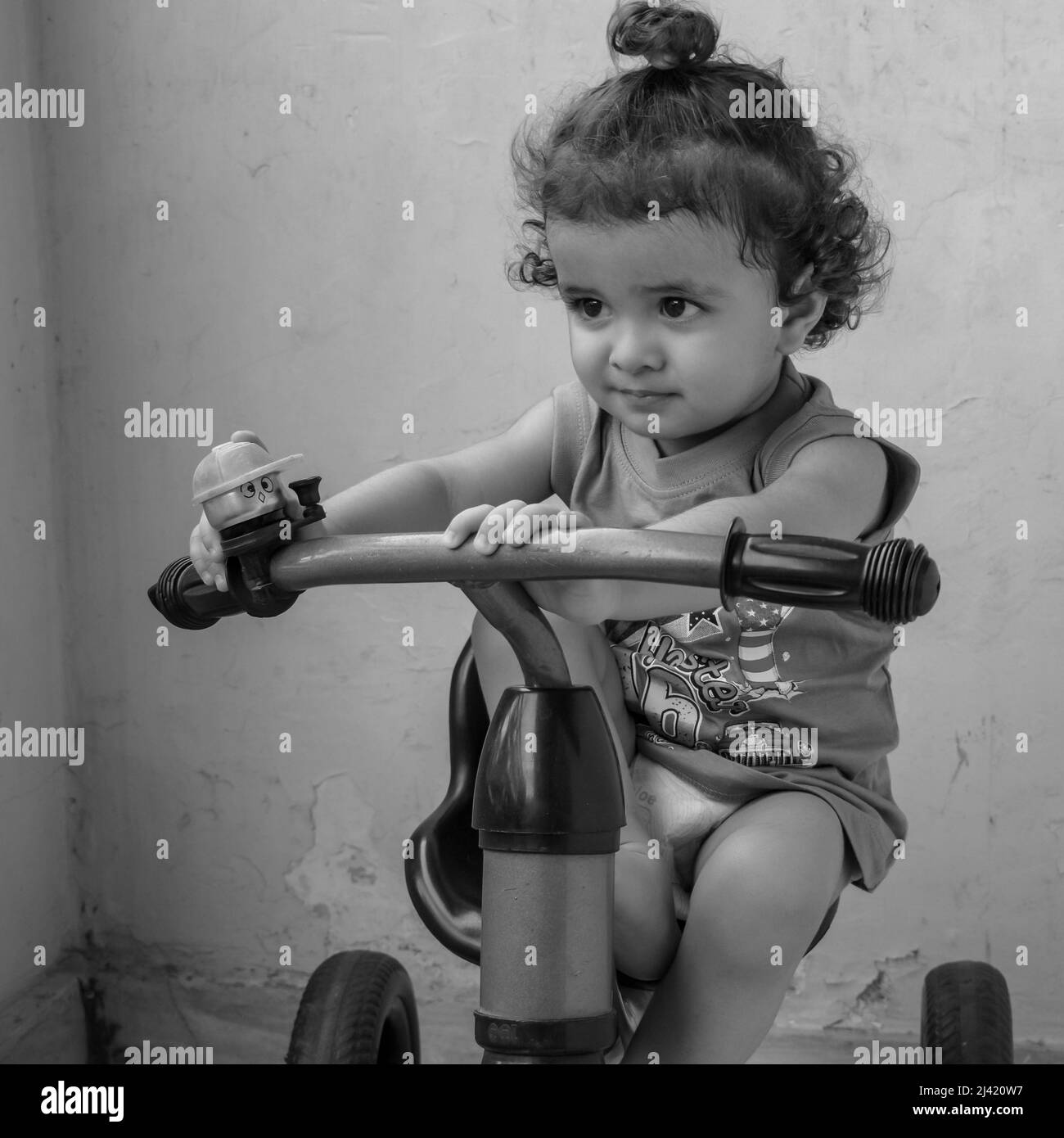 Cute little boy Shivaay driving cycle at home balcony during summer ...