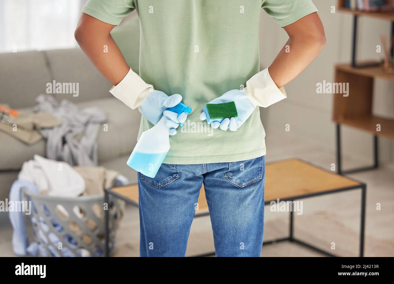 Ready to tackle the dirt. Shot of a man holding a bottle of detergent ...