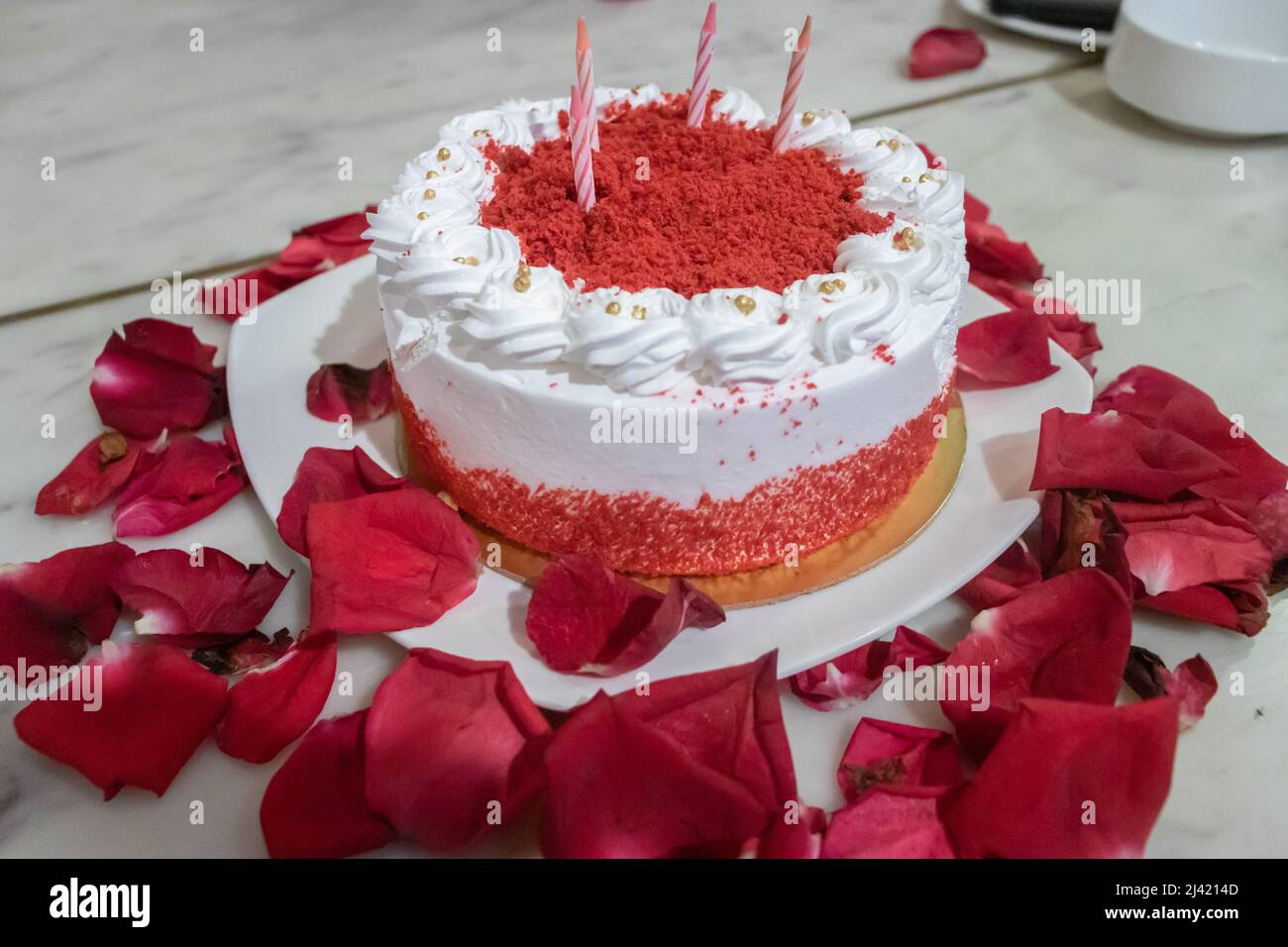 delicious red moose cake decorated with rose petals and candles ...