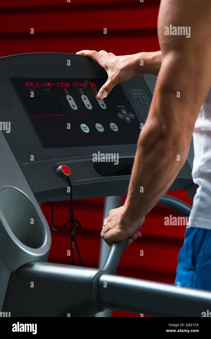 Male hands on control panel of cardio machine Stock Photo - Alamy