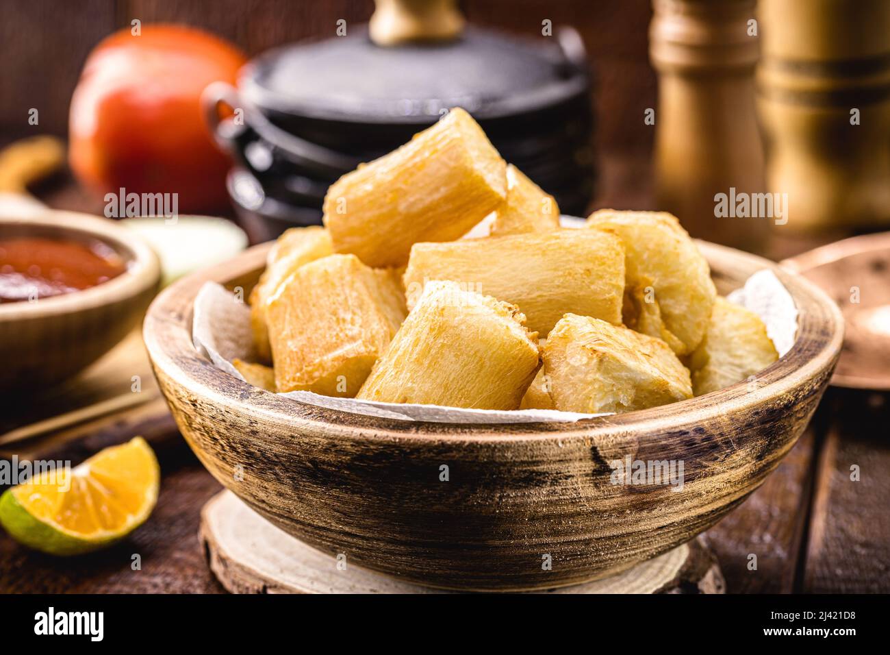 large portion of fried cassava, in a rustic rural setting, typical food ...