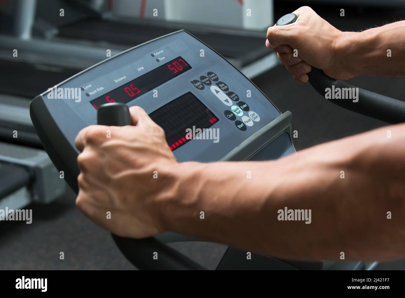 Male hands on control panel of cardio machine Stock Photo - Alamy