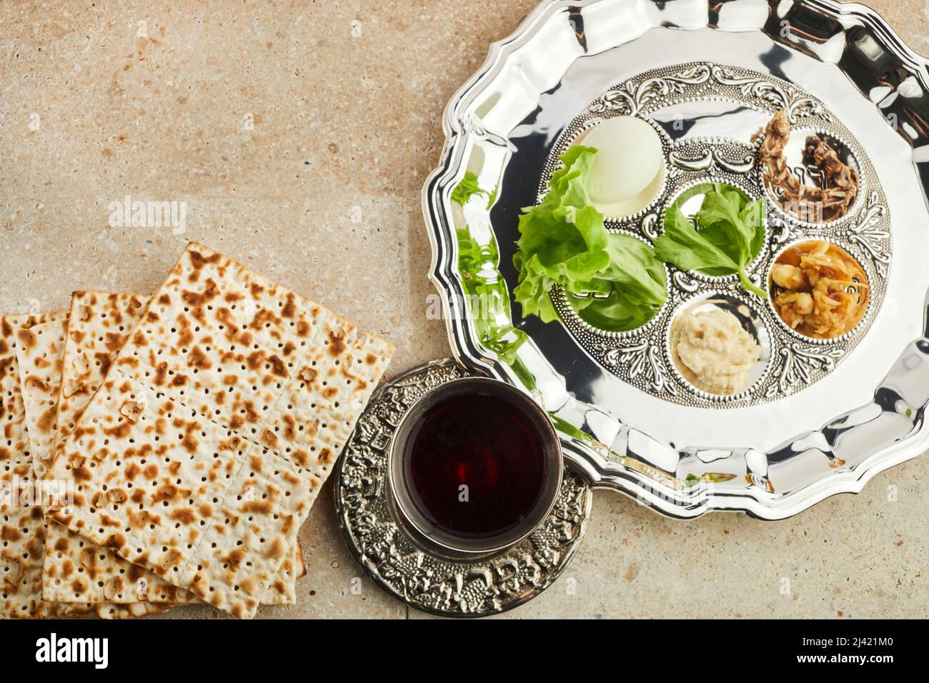 Passover Seder plate with traditional food ontravertine stone ...