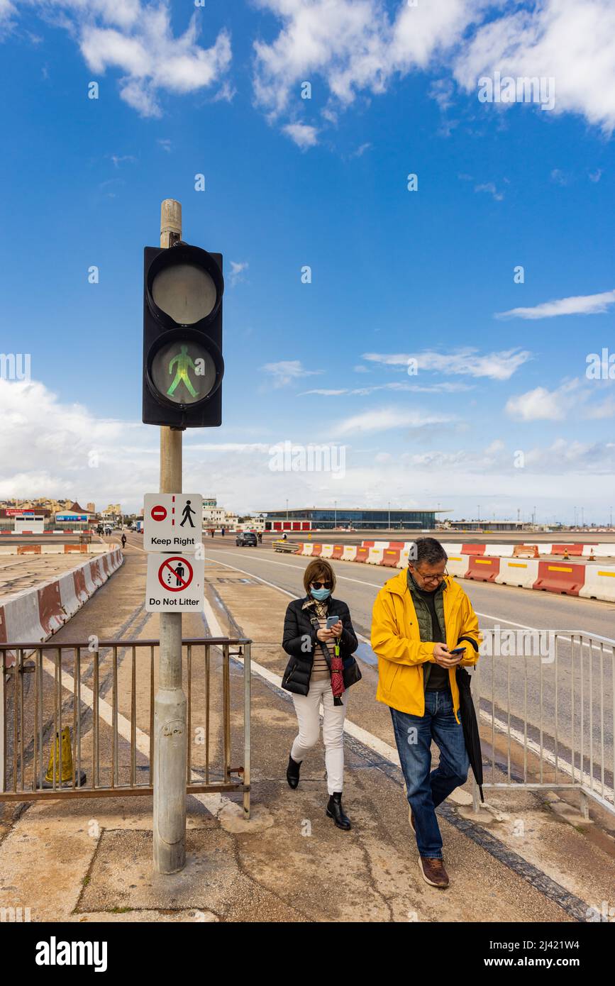 GIBRALTAR, GREAT BRITAIN - APRIL 9 2022: Tourists crossing the airport ...