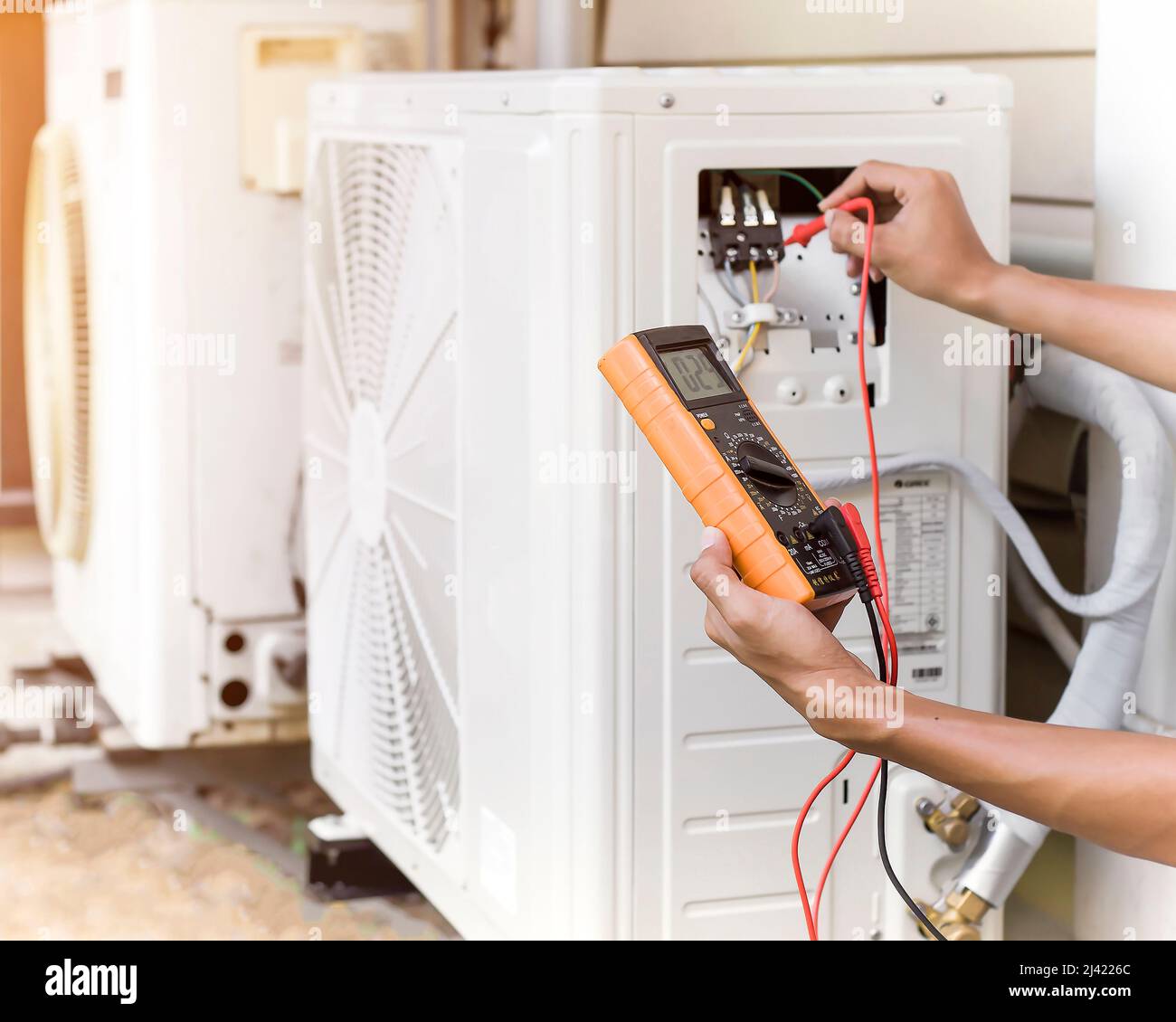 Air conditioner technician checks the operation of industrial air ...