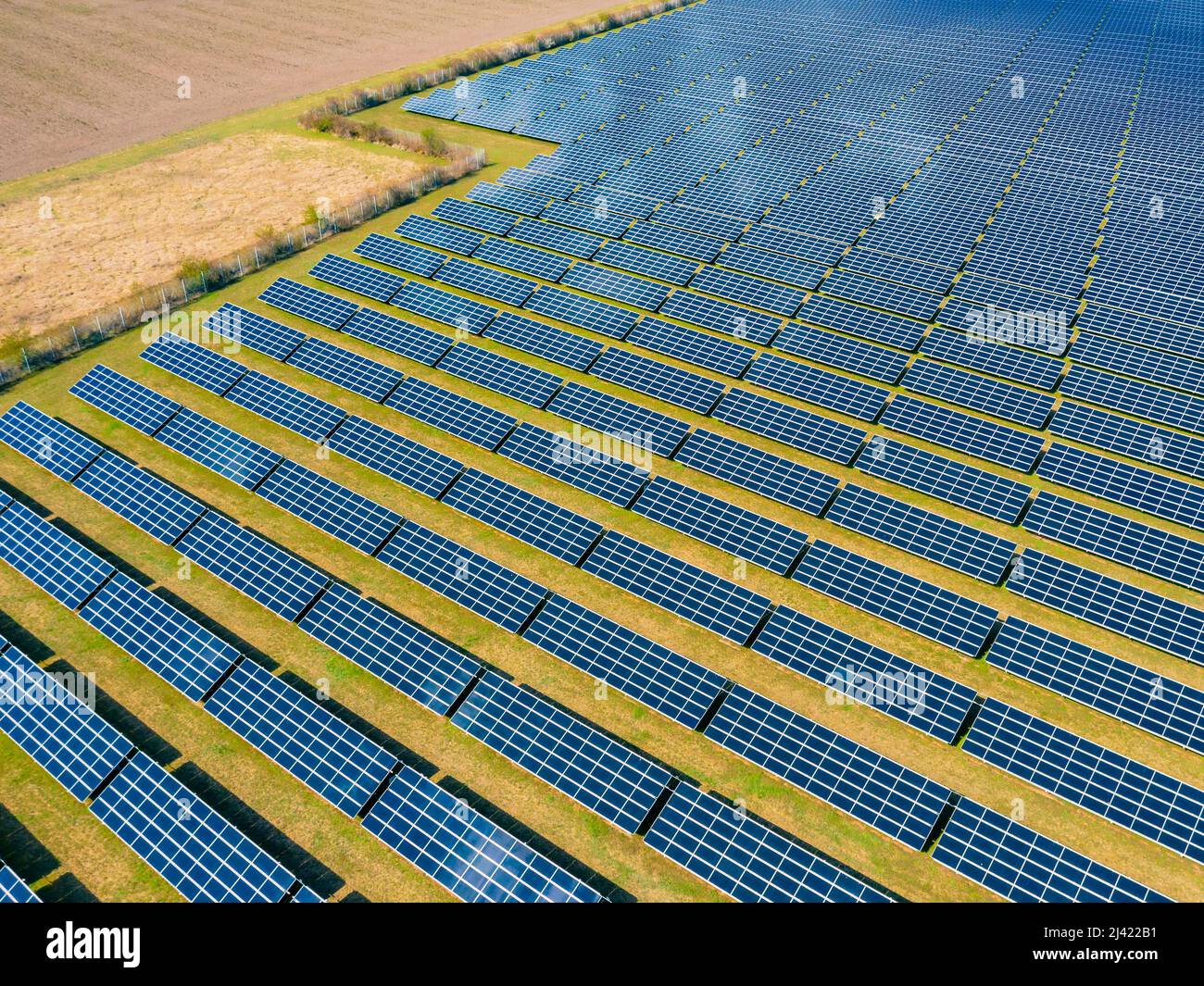 Many photovoltaic panels of a solar farm as competition to agriculture ...