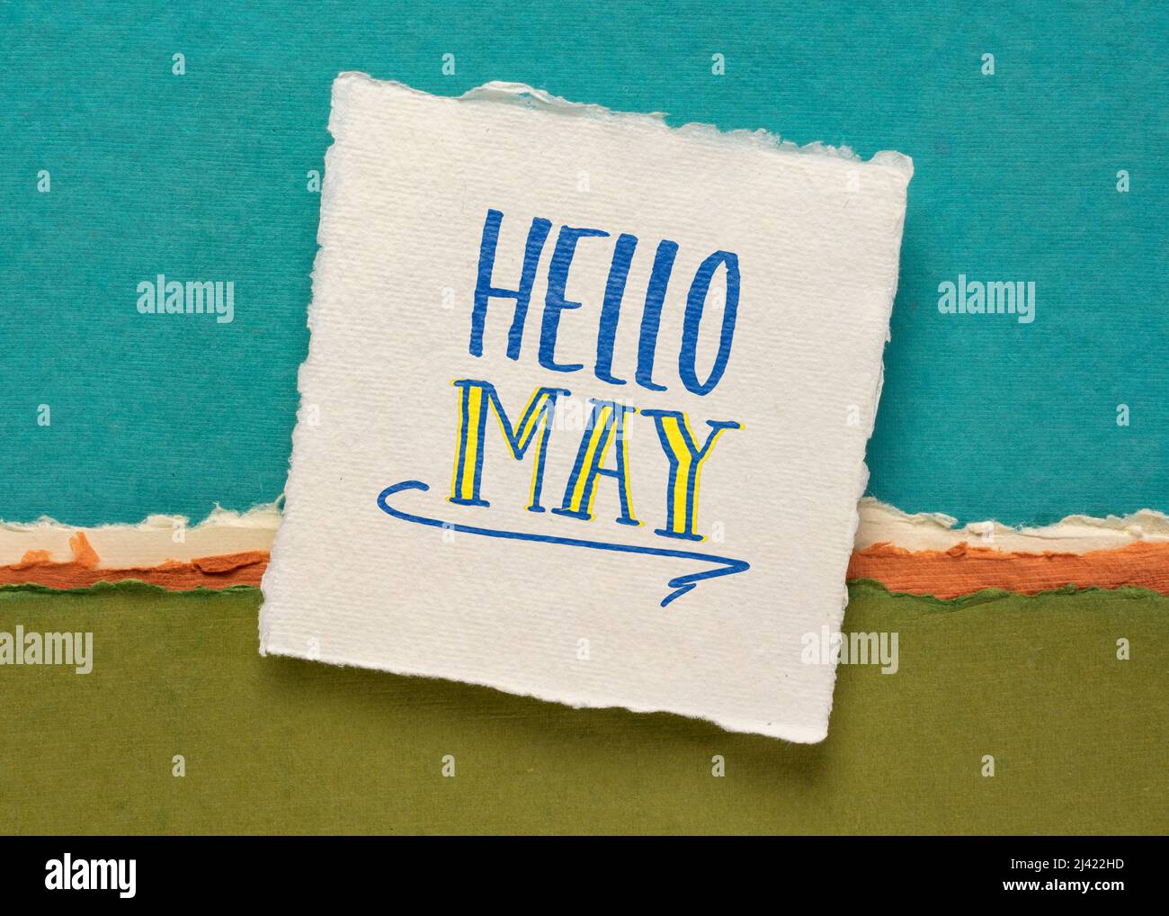 Hello May greeting note - handwriting on a white handmade paper against ...