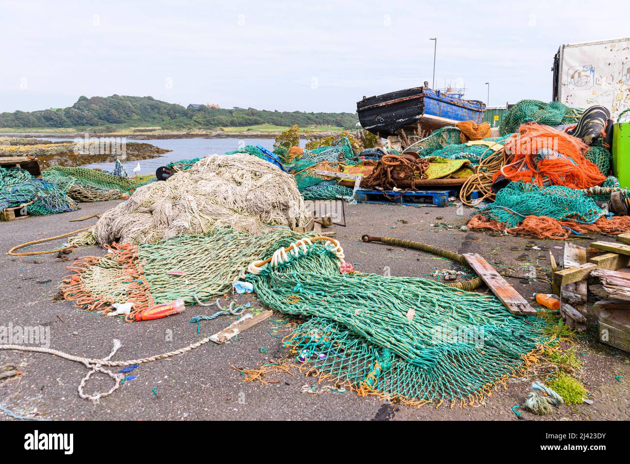 Discarded trawler fishing nets scattered around a harbour Stock Photo ...