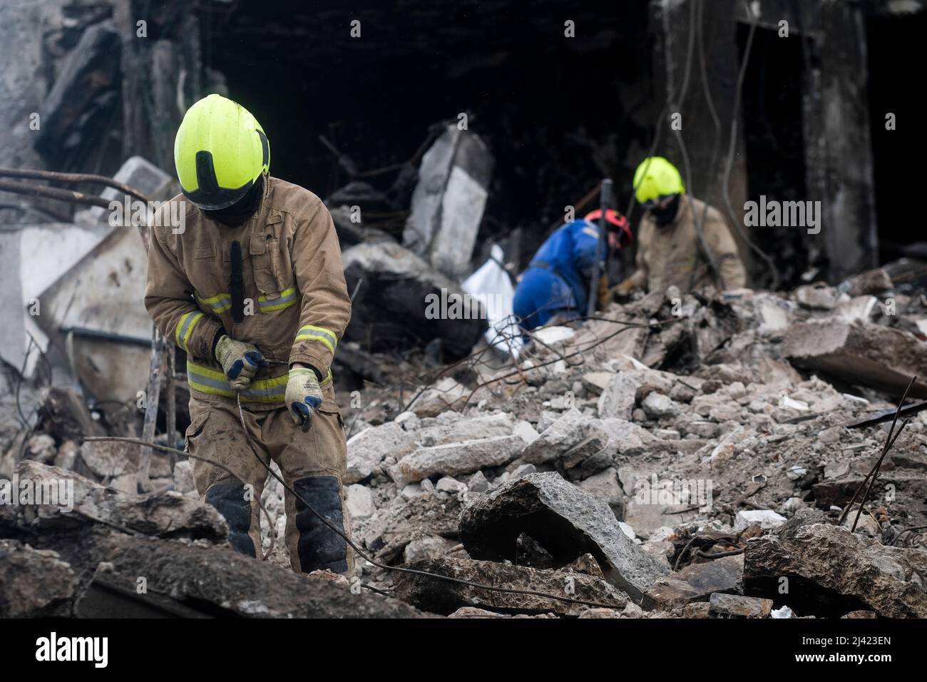 Rescue workers continue to excavate and remove the debris from a ...