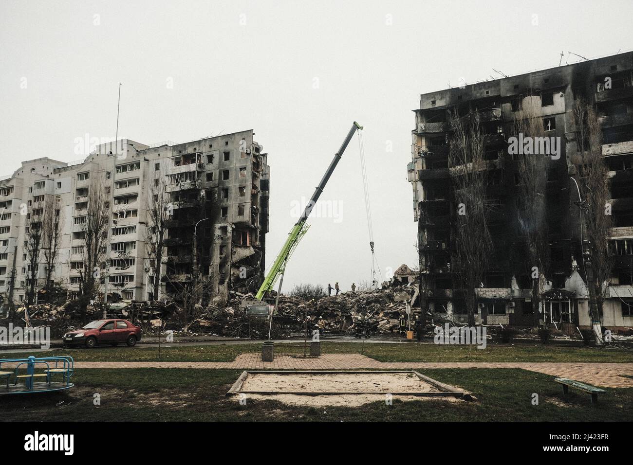 Rescue workers continue to excavate and remove the debris from a ...