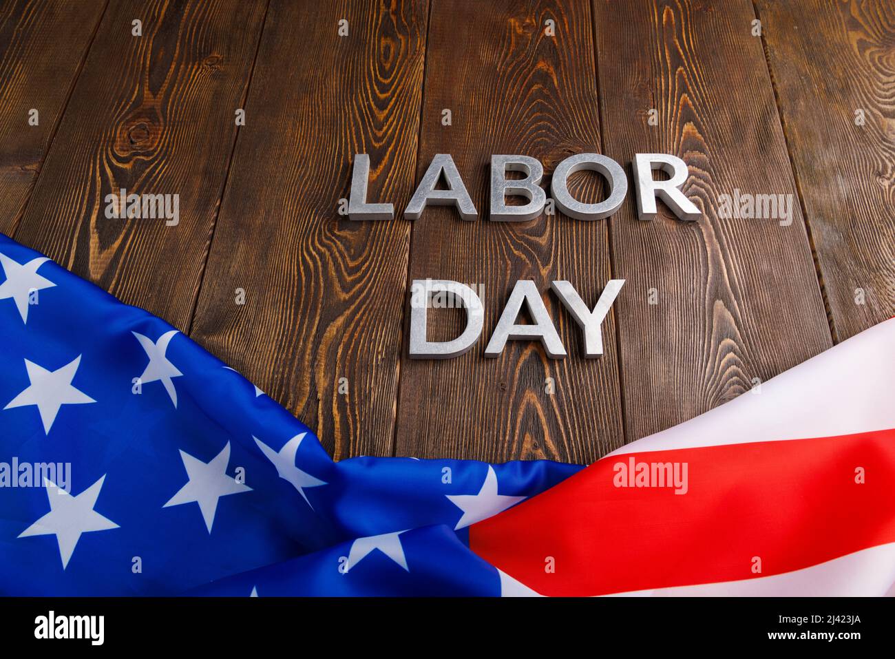 words labor day laid with silver metal letters on wooden surface with ...