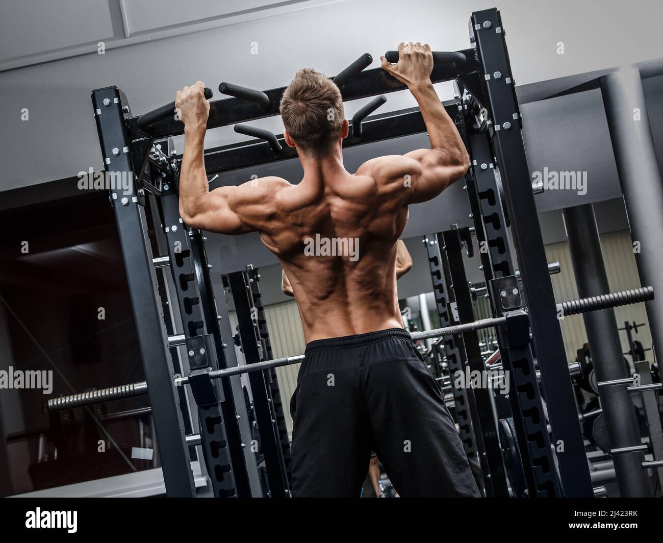 Muscular man during workout in the gym Stock Photo - Alamy